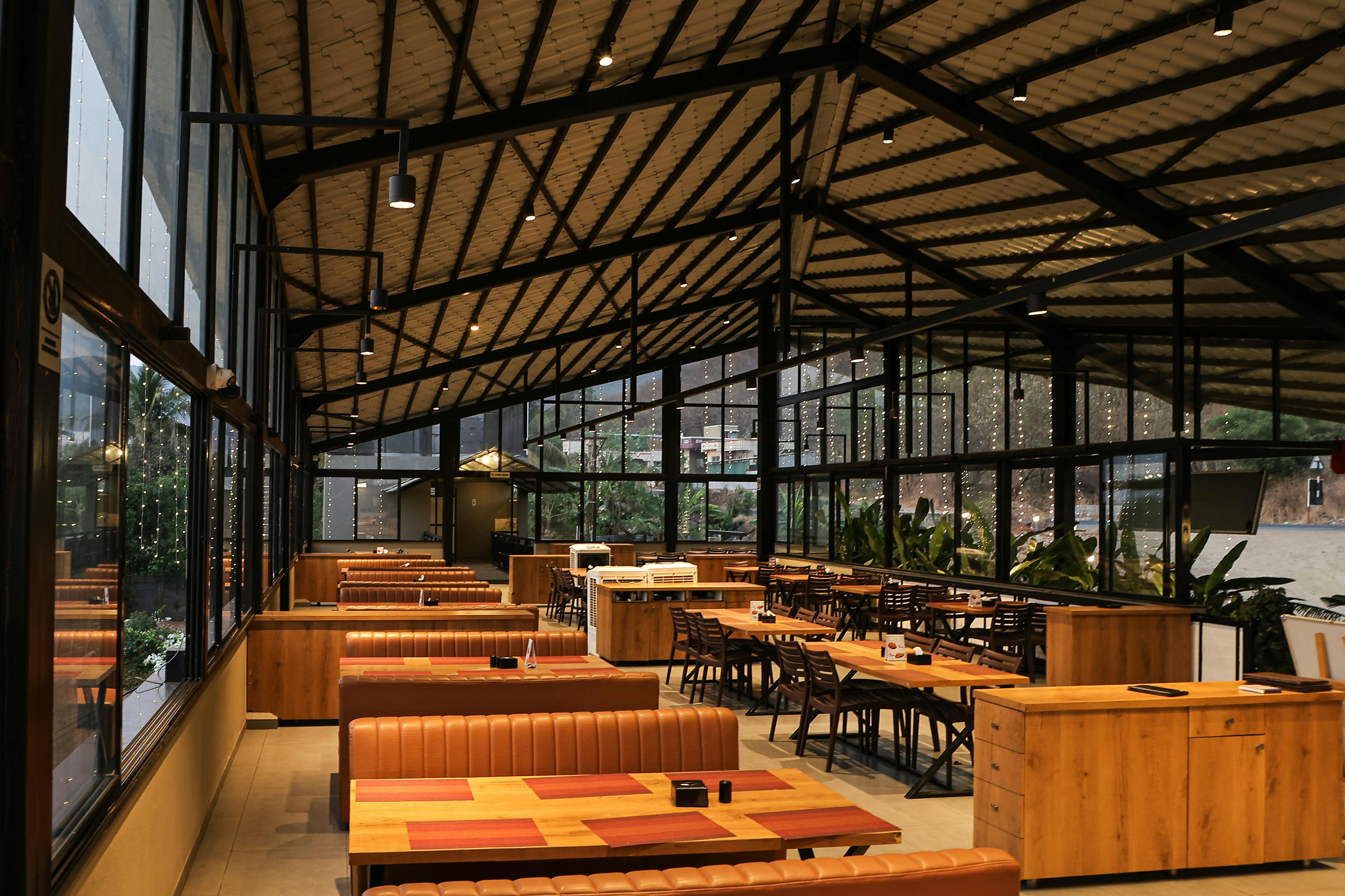 Modern Glass Restaurant Interior with Elegant Decor · Free Stock Photo