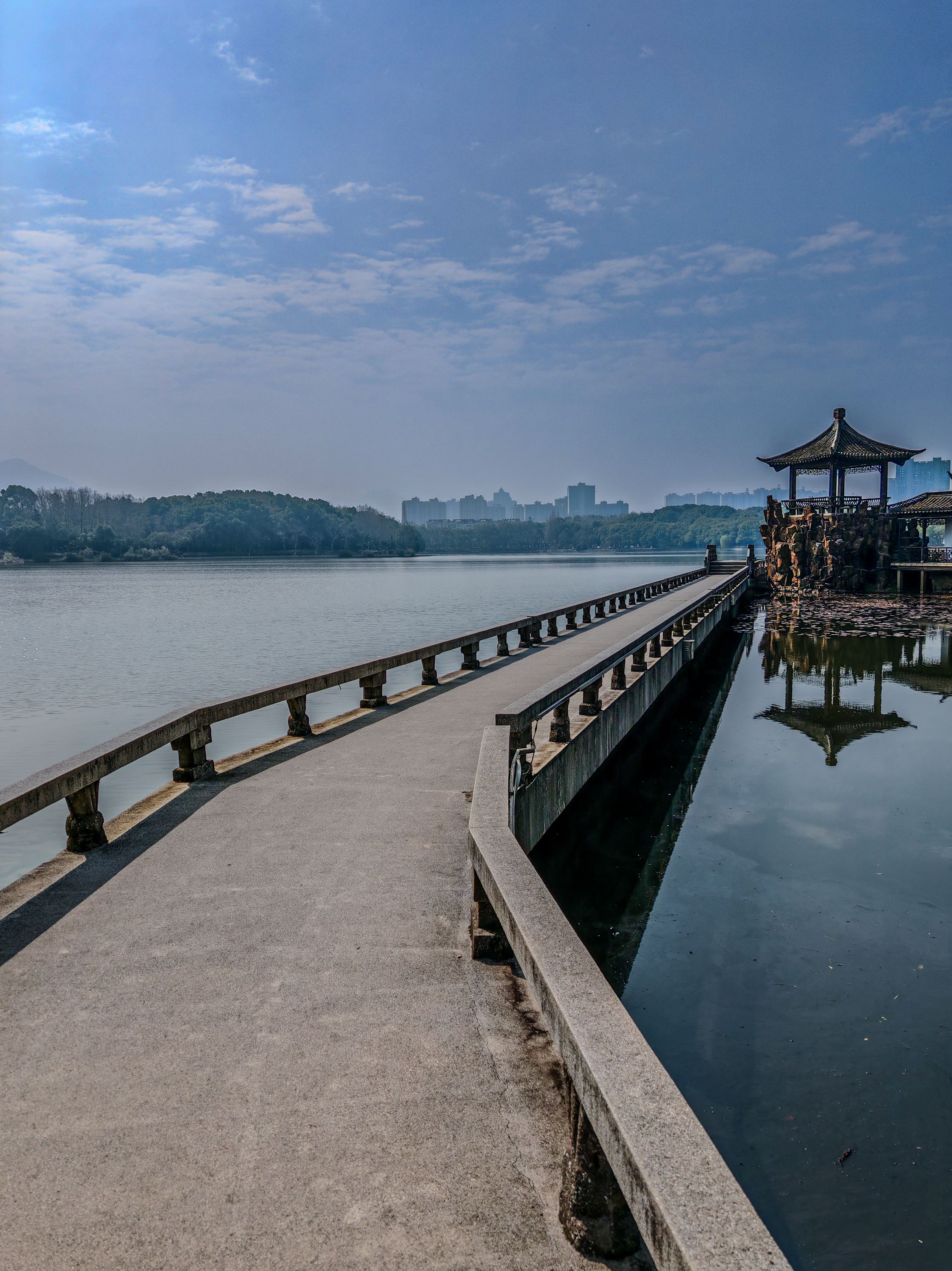 Serene Lakeside Walkway and Pagoda Scene · Free Stock Photo