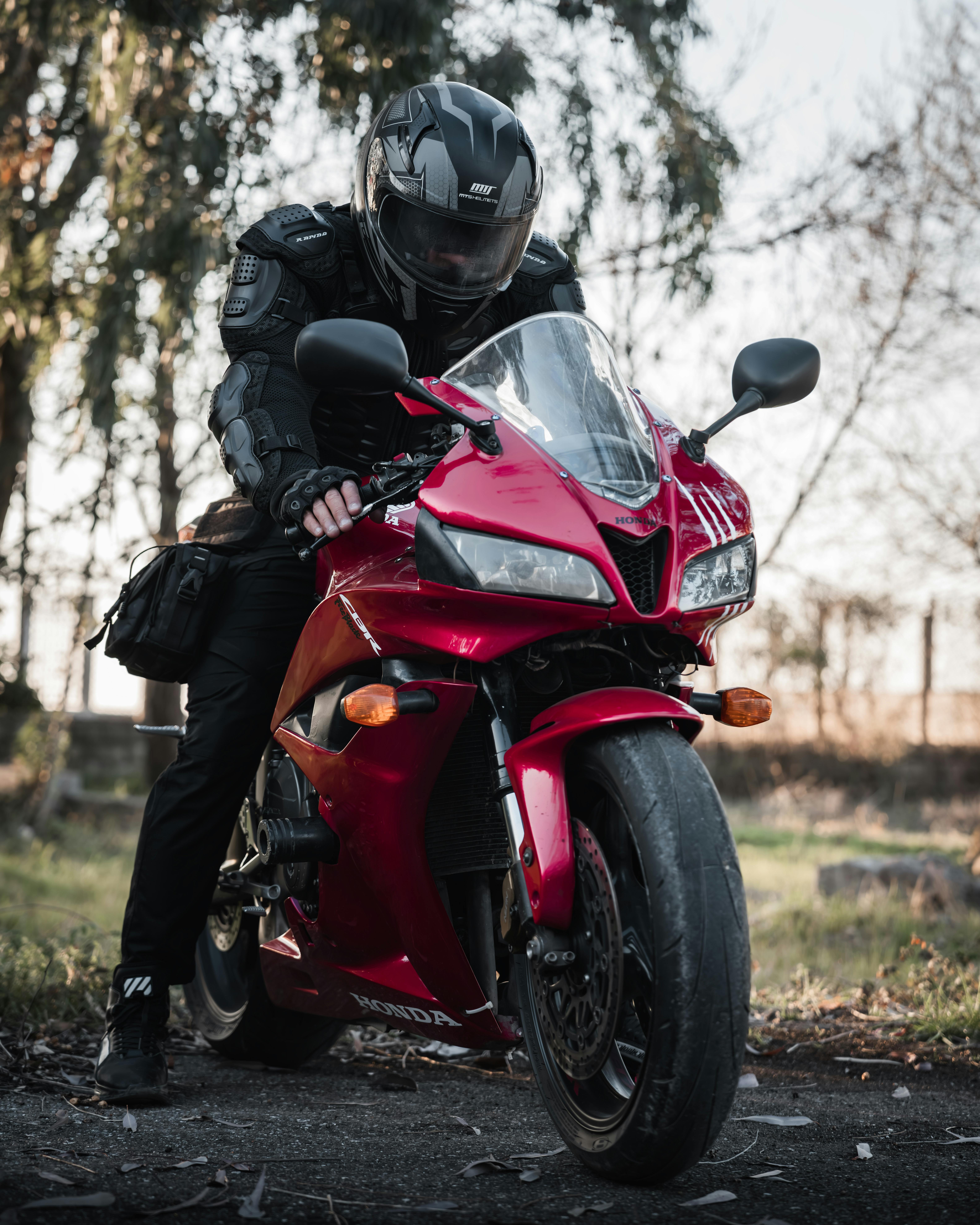 Motorcyclist on Red Sport Bike in Outdoor Setting · Free Stock Photo