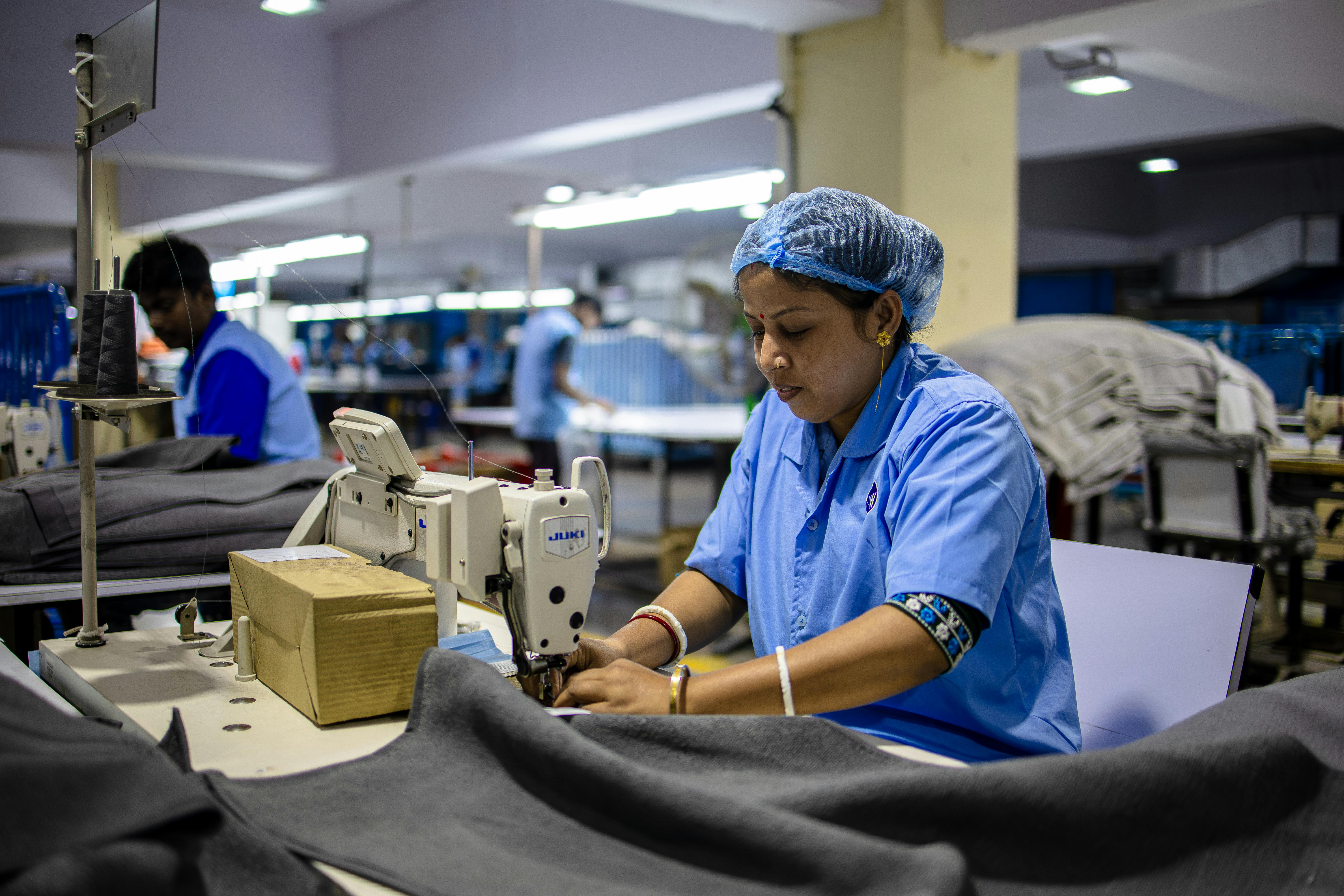 Female Factory Worker Sewing in Textile Industry · Free Stock Photo