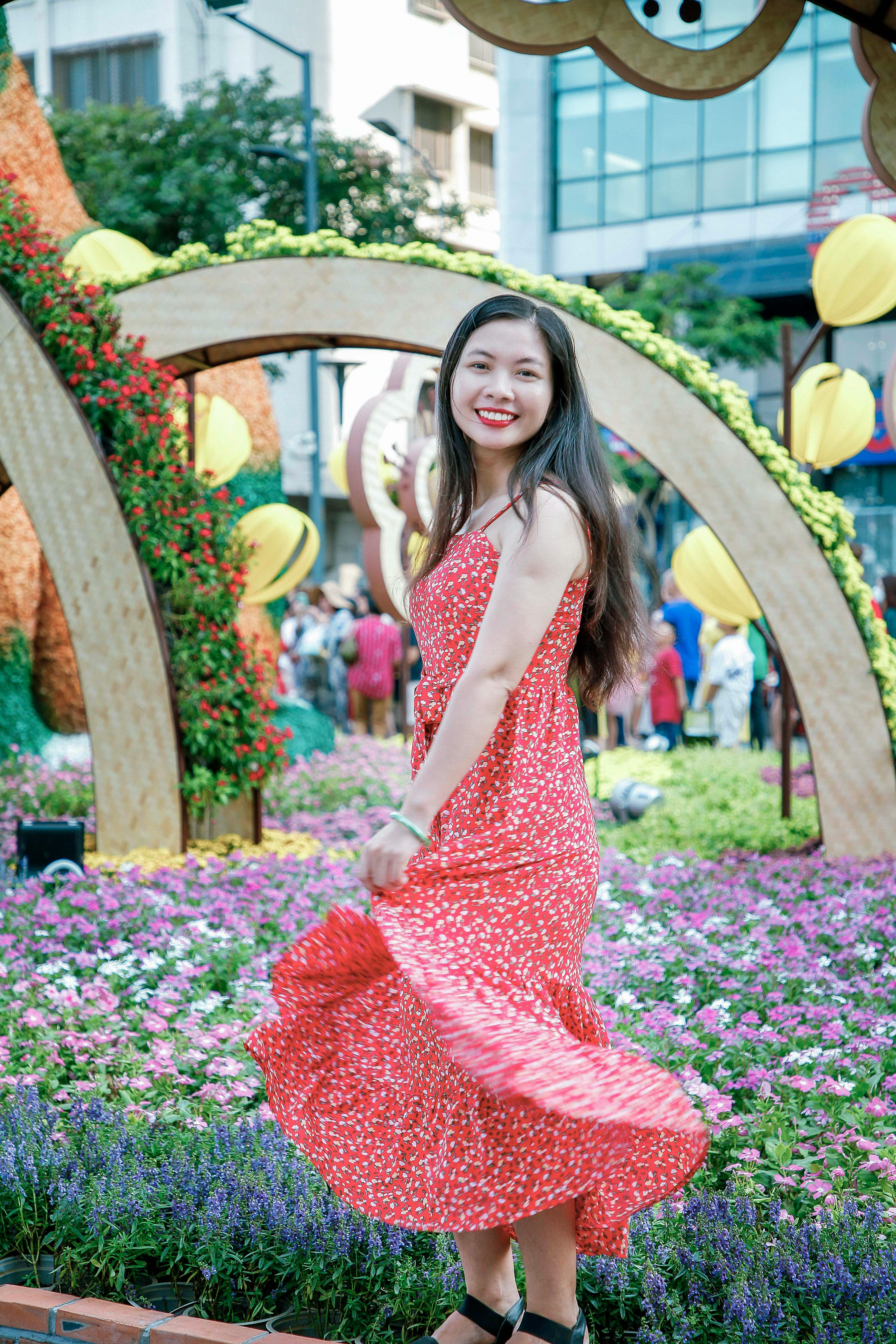Woman in Red Dress Twirling Among Flowers · Free Stock Photo