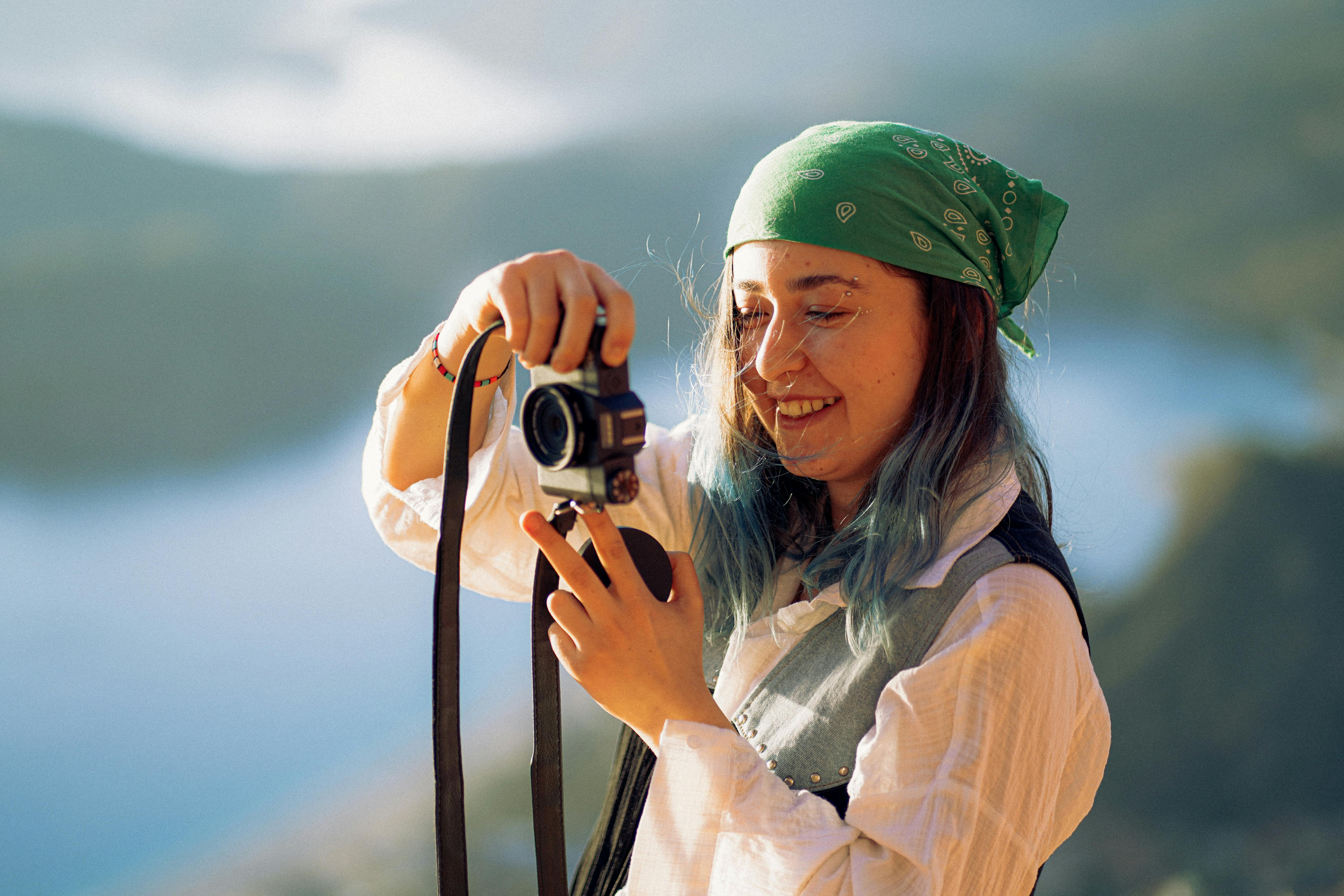 Young woman enjoying photography outdoors · Free Stock Photo