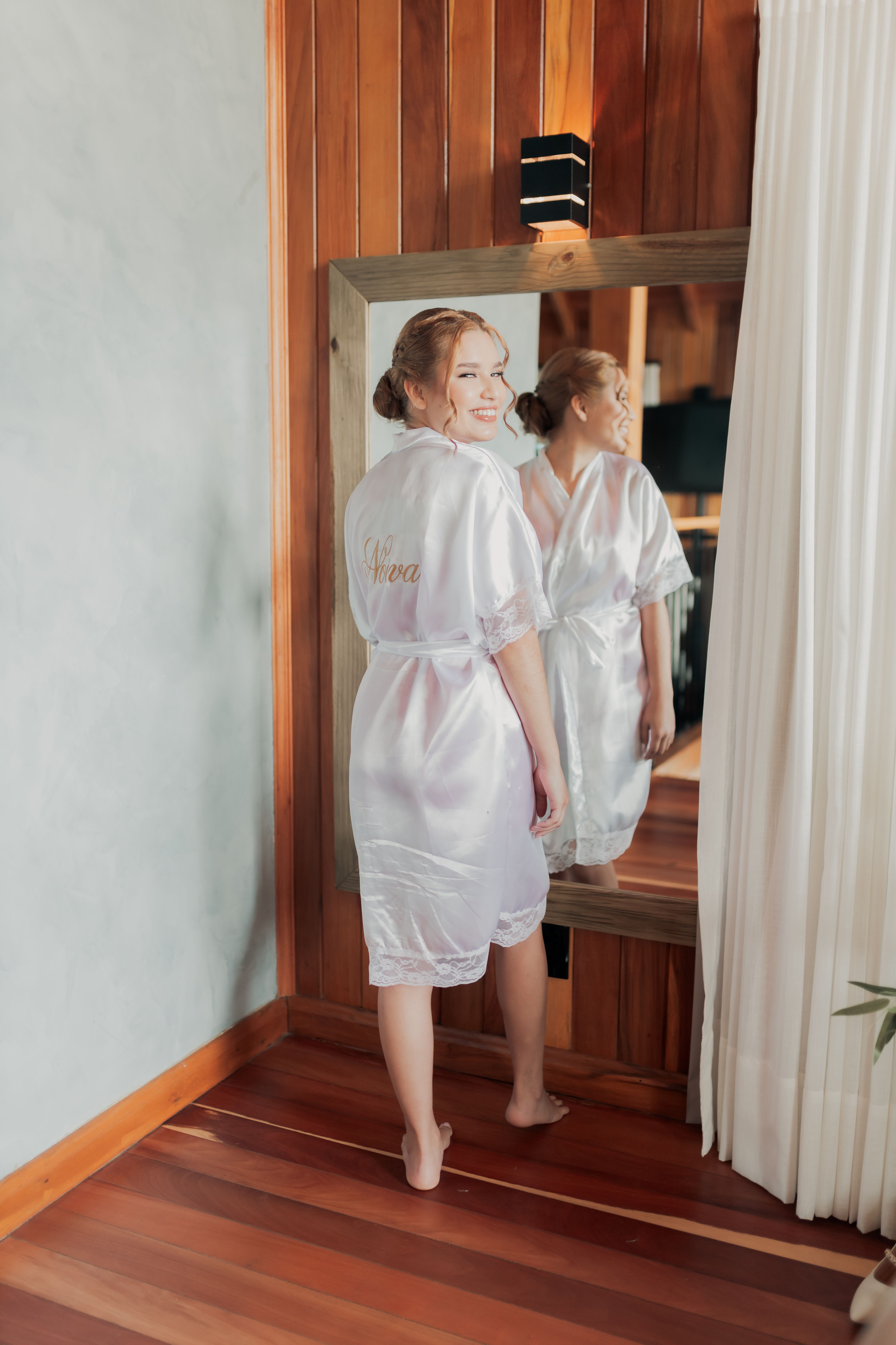 Woman in Satin Robe Smiling at Mirror Indoors · Free Stock Photo