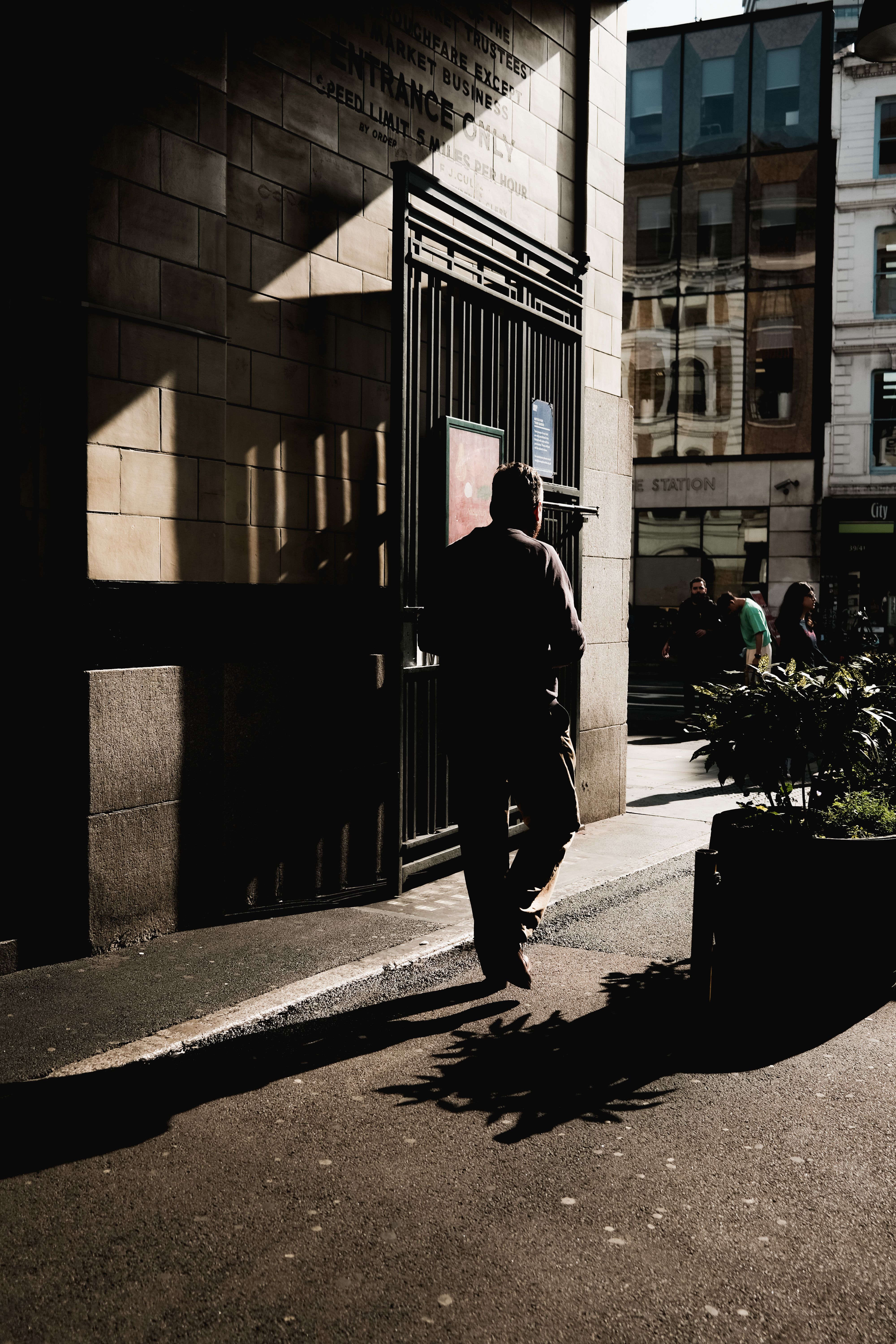 Man Walking in Urban Sunlit Alley · Free Stock Photo
