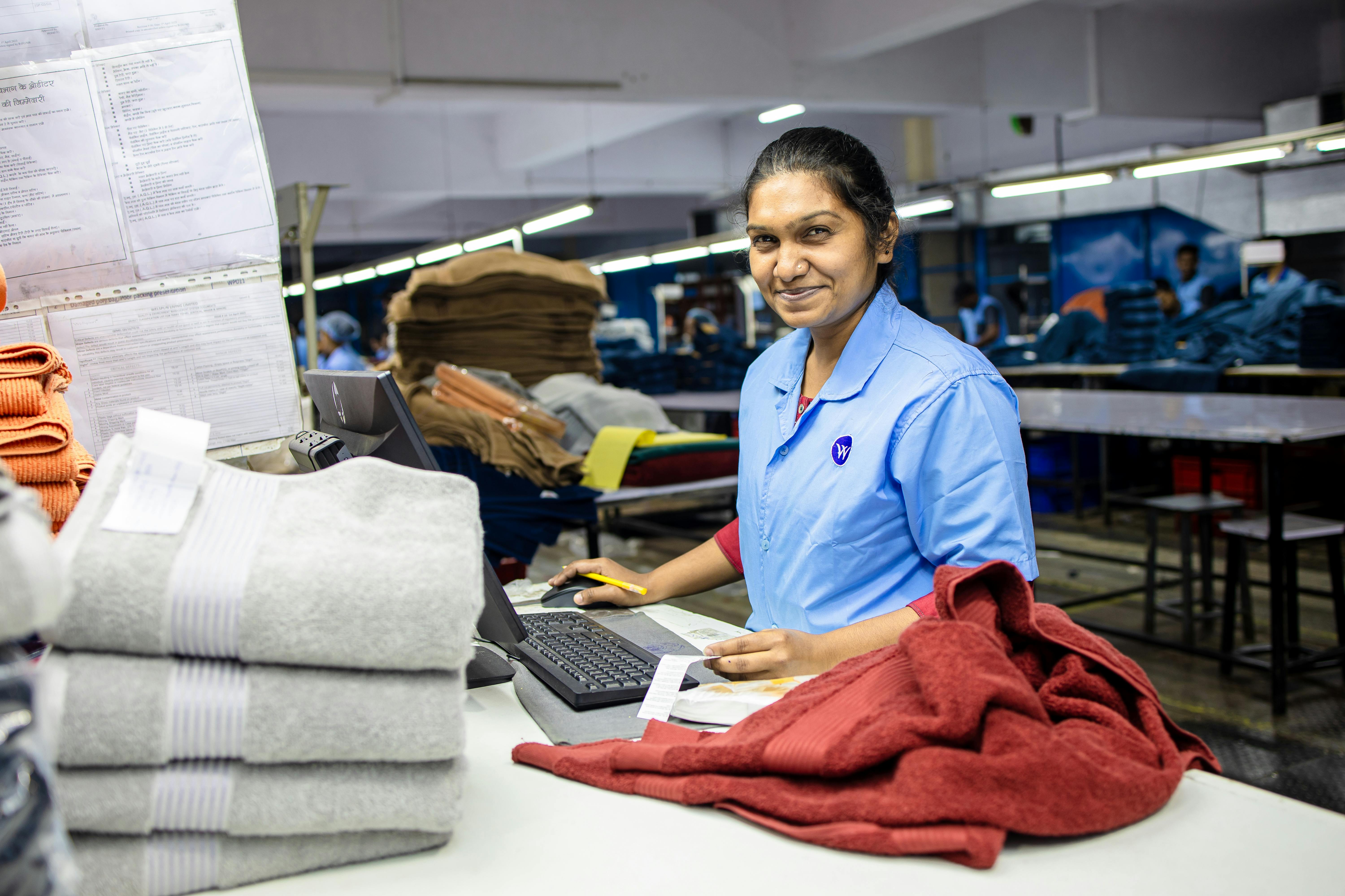 Smiling Factory Worker at Textile Manufacturing Plant · Free Stock Photo