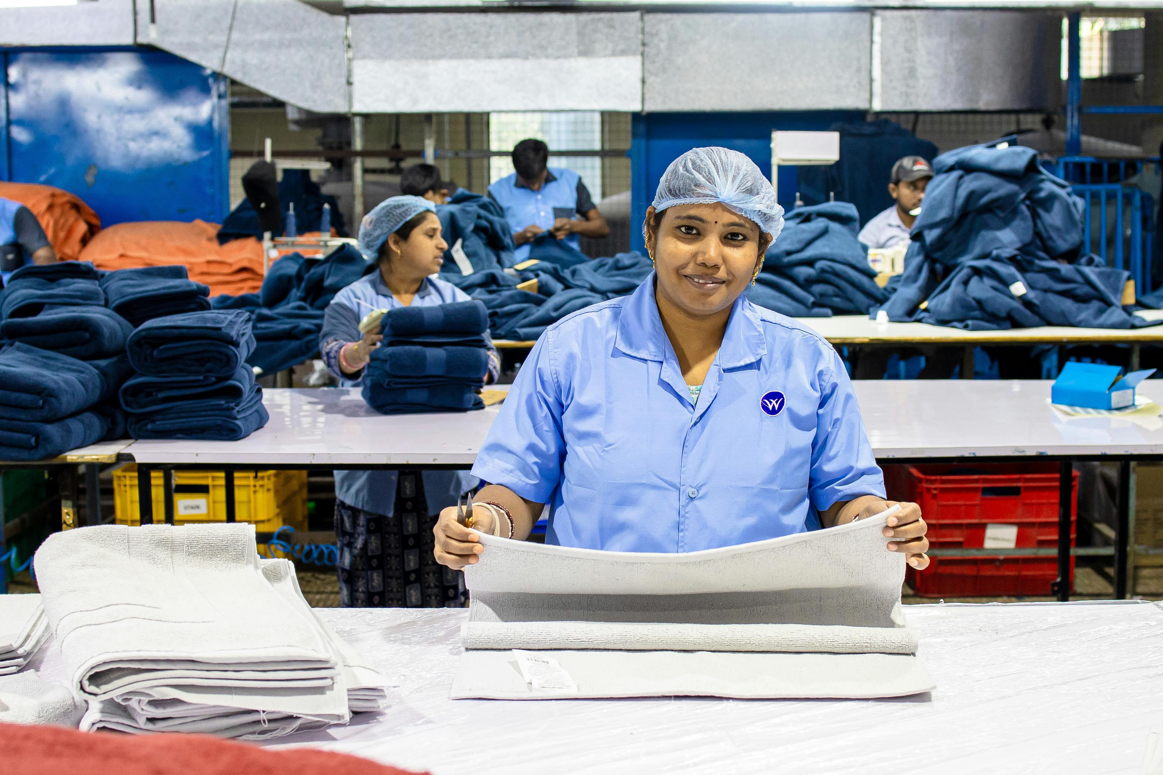 Female Factory Worker Folding Textiles at Production Line · Free Stock ...