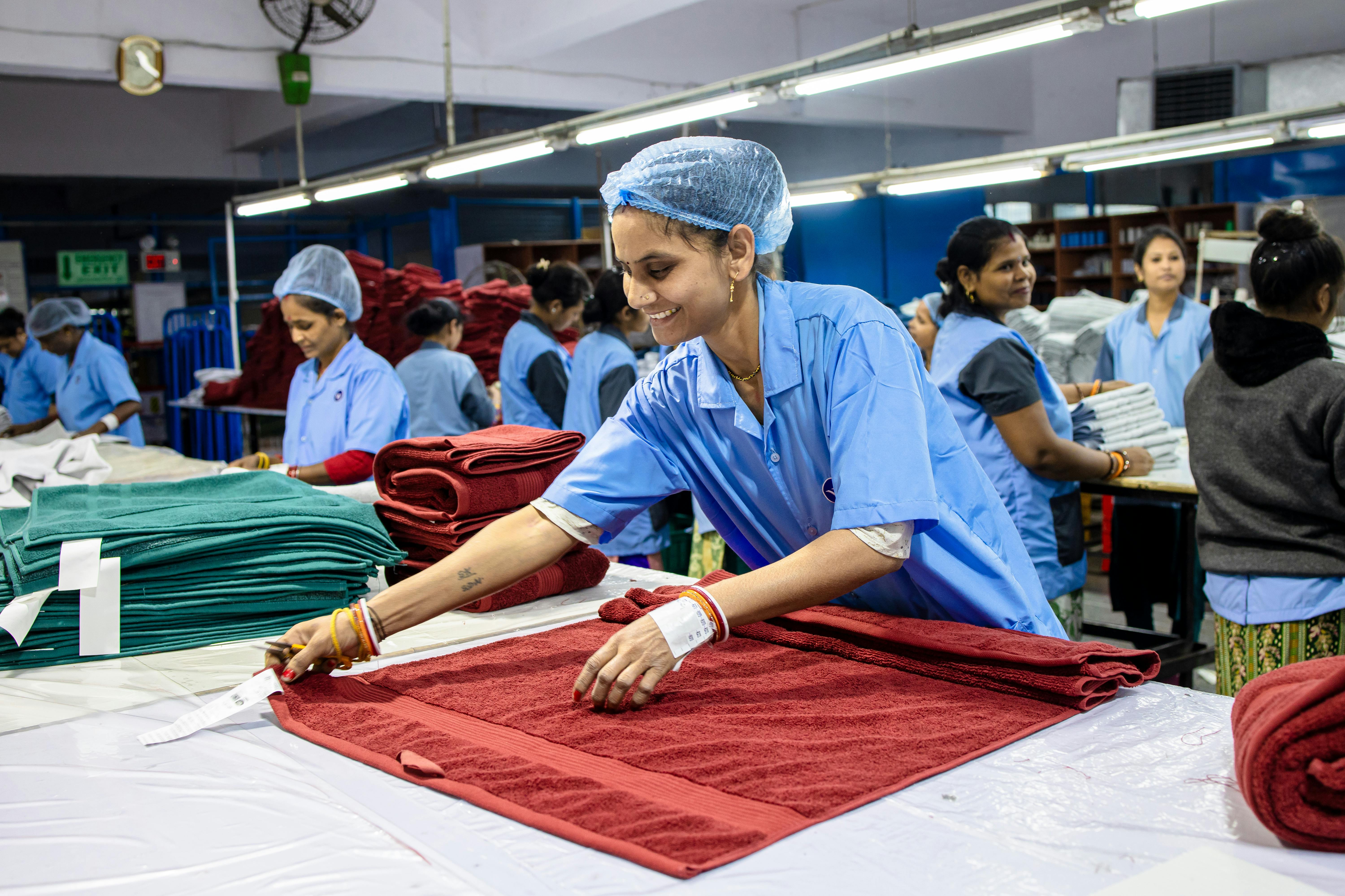 Textile Factory Workers Folding Towels · Free Stock Photo