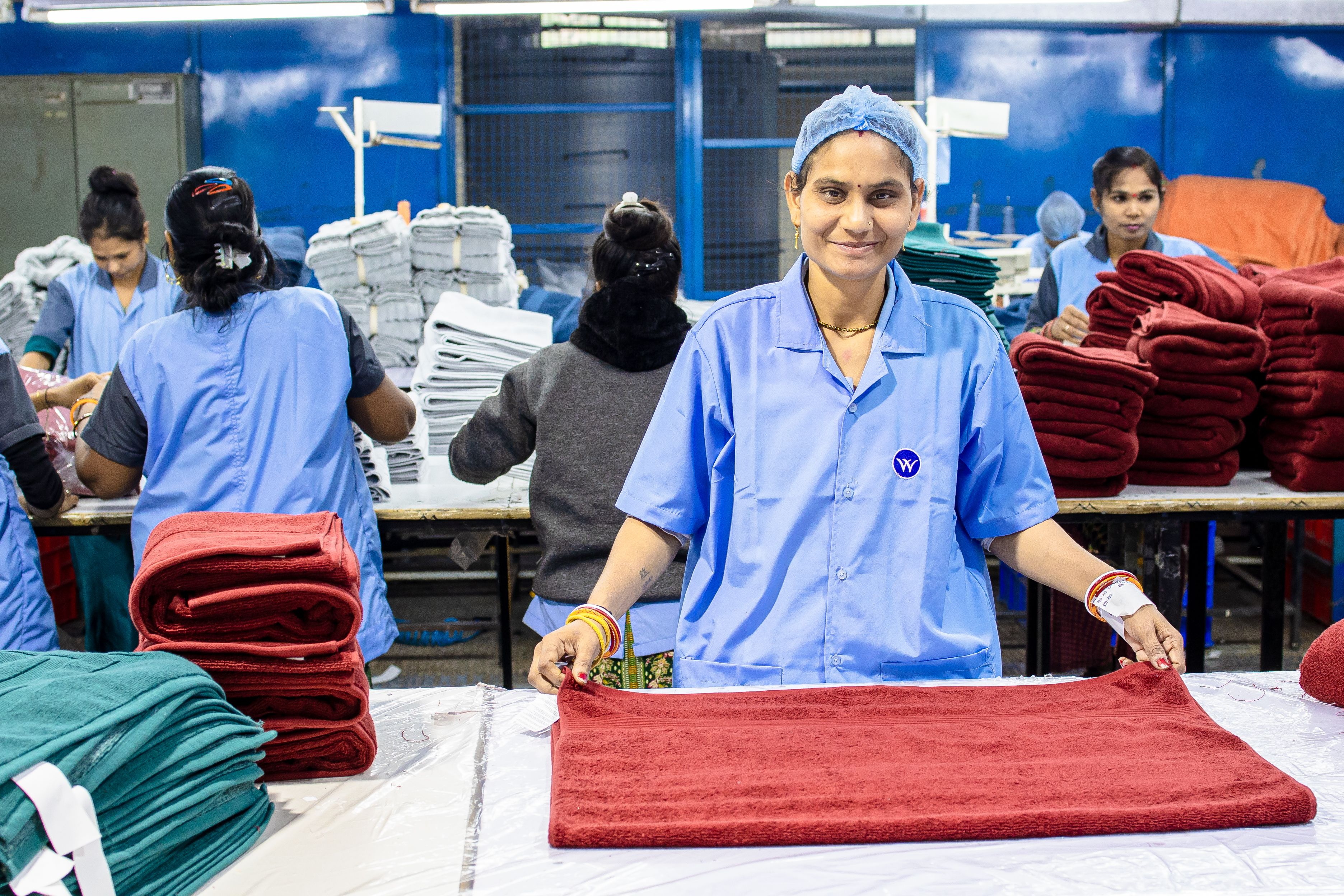 Women Factory Workers Folding Textiles Indoors · Free Stock Photo