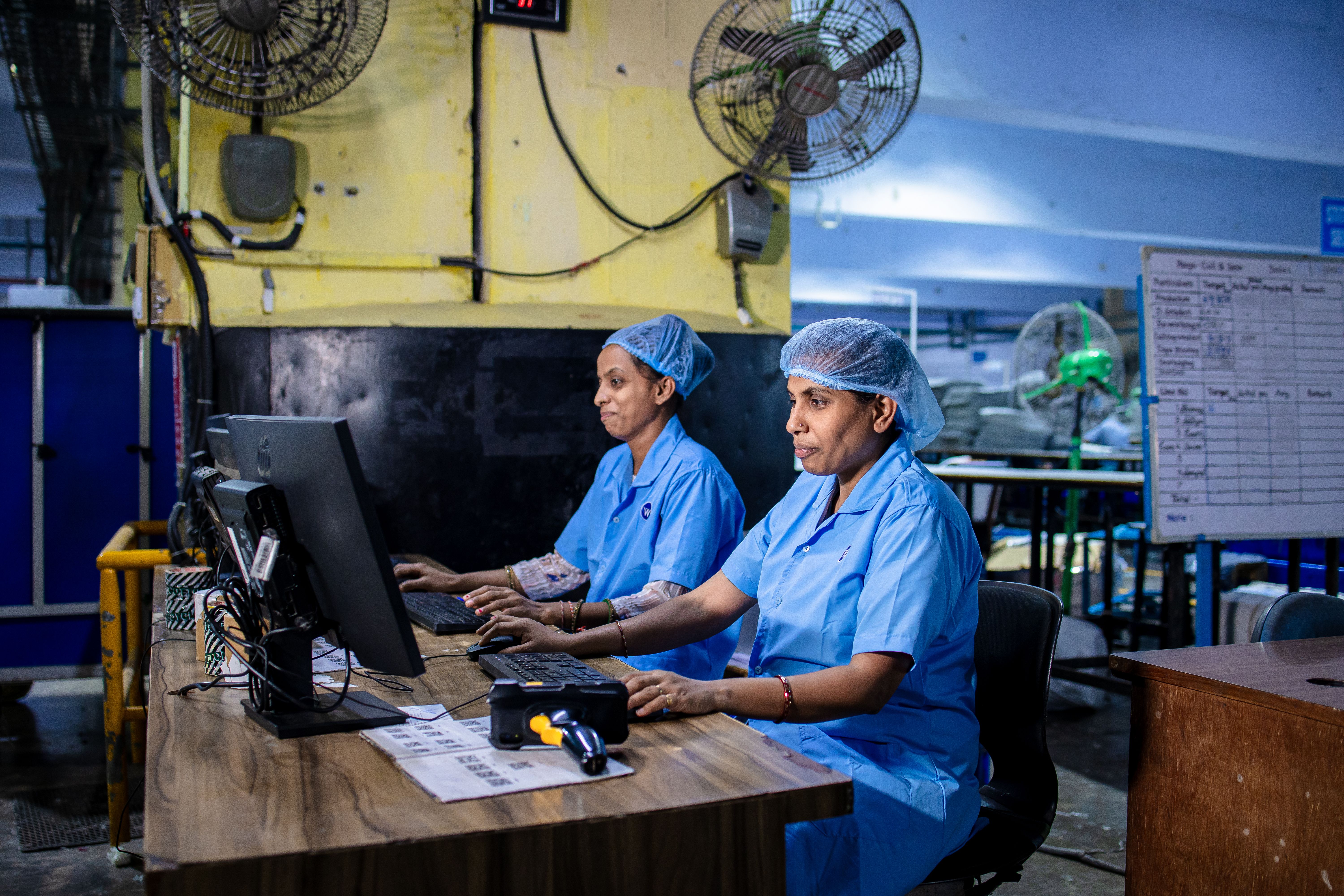 Textile Factory Workers Using Computers Indoors · Free Stock Photo