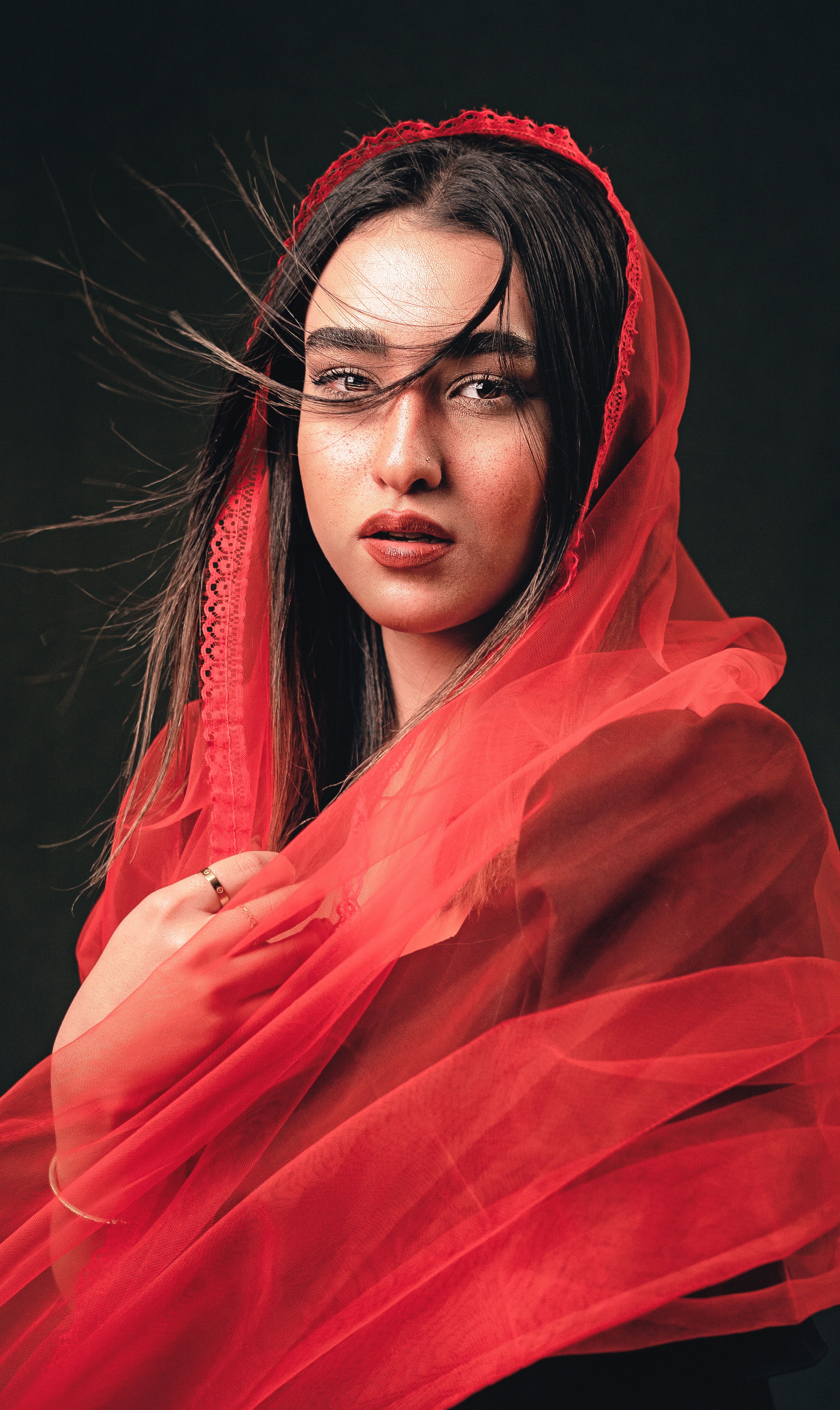 Portrait of Woman in Red Veil with Windblown Hair · Free Stock Photo