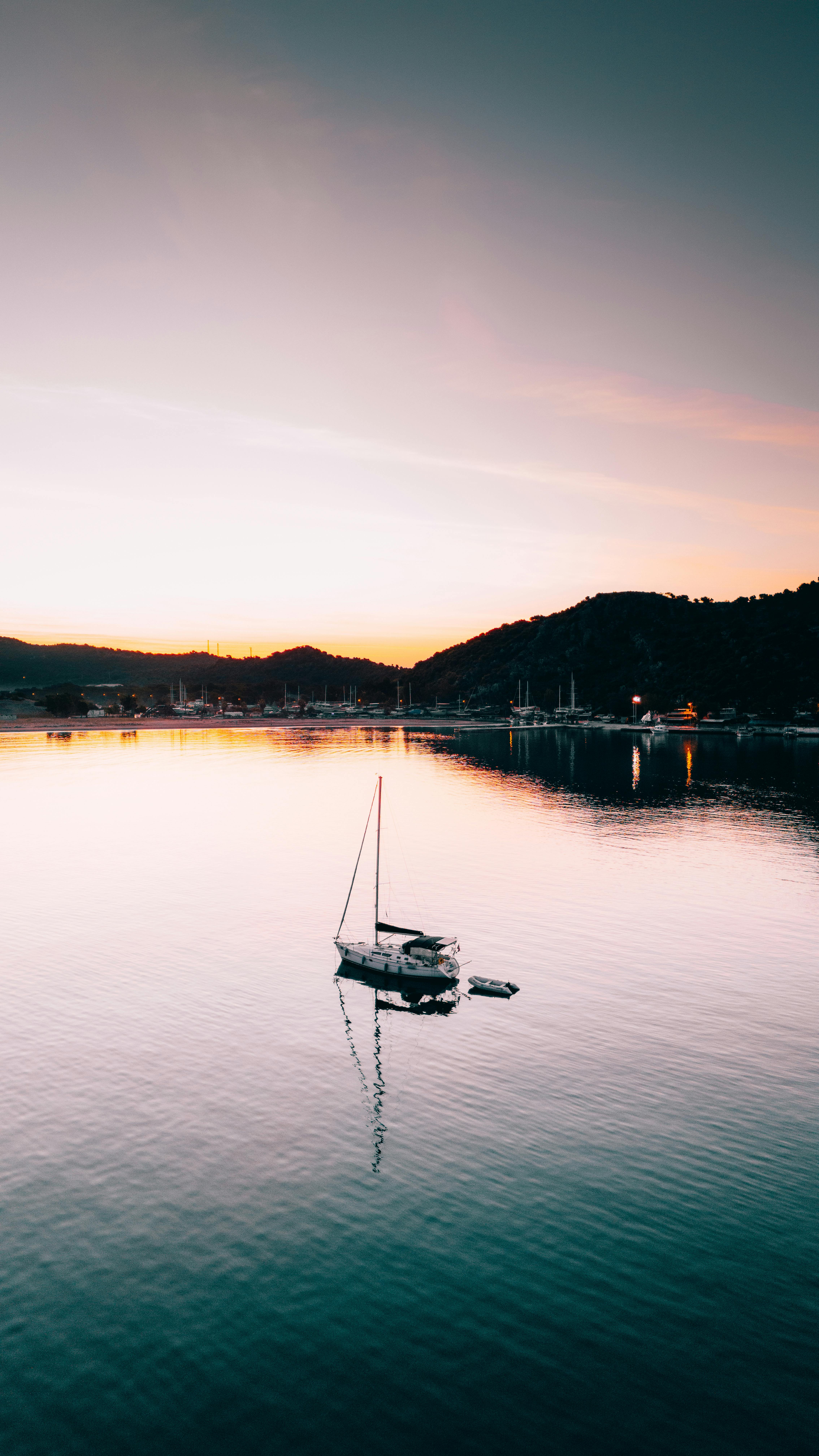 Tranquil Sunset Over Harbor with Sailboat · Free Stock Photo