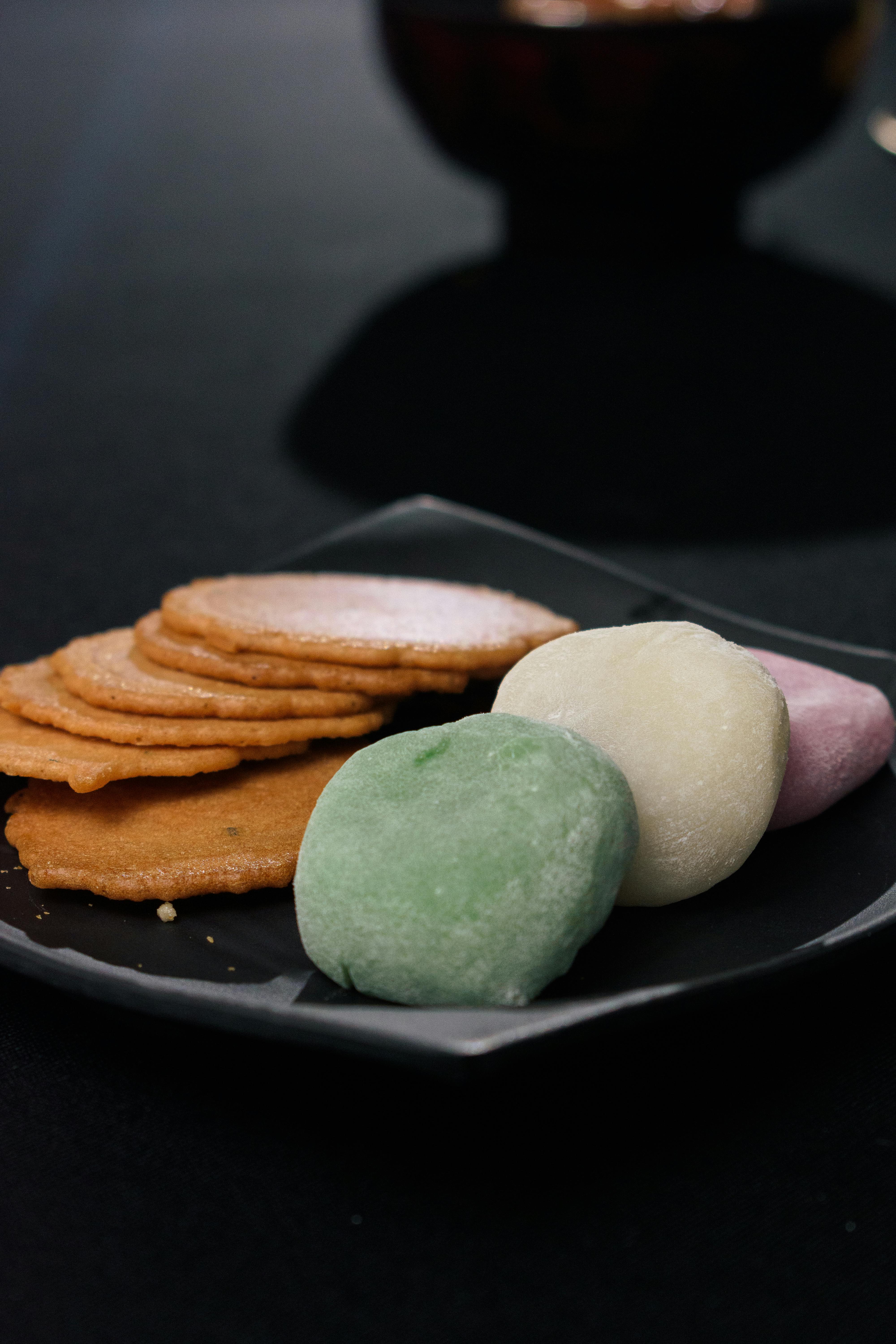 Traditional Mochi and Senbei on Black Plate · Free Stock Photo