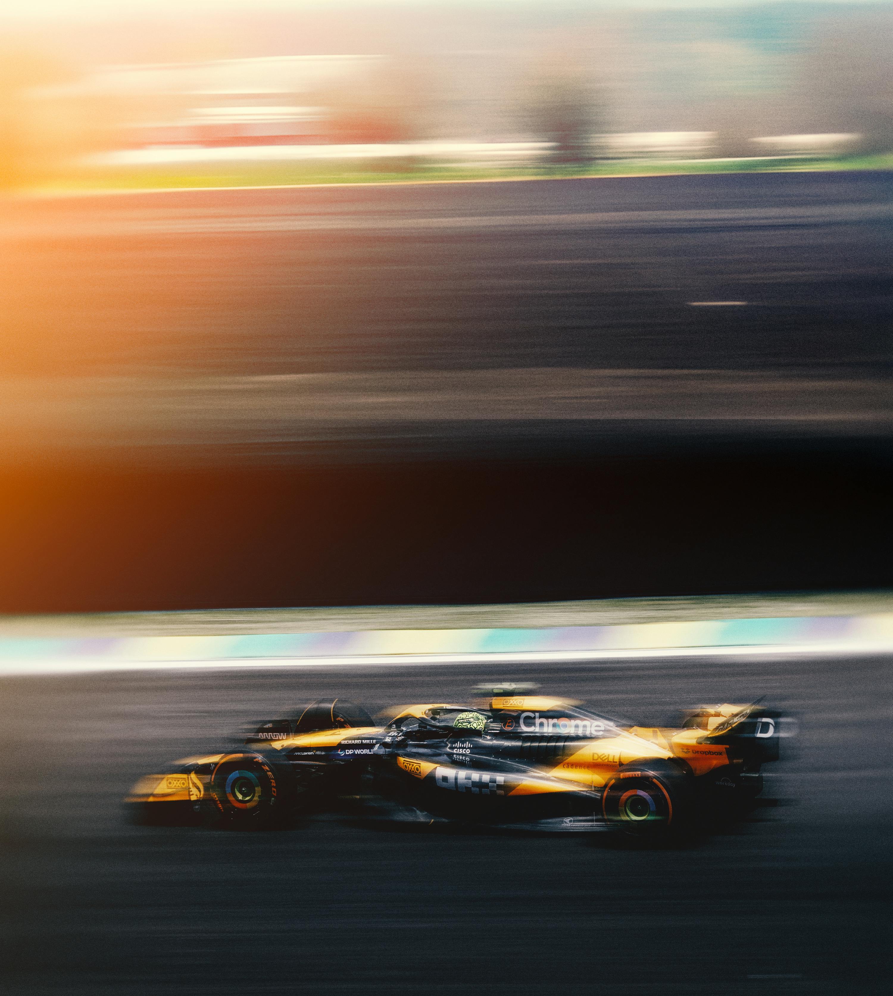 High-Speed Race Car on Track at Sunset · Free Stock Photo