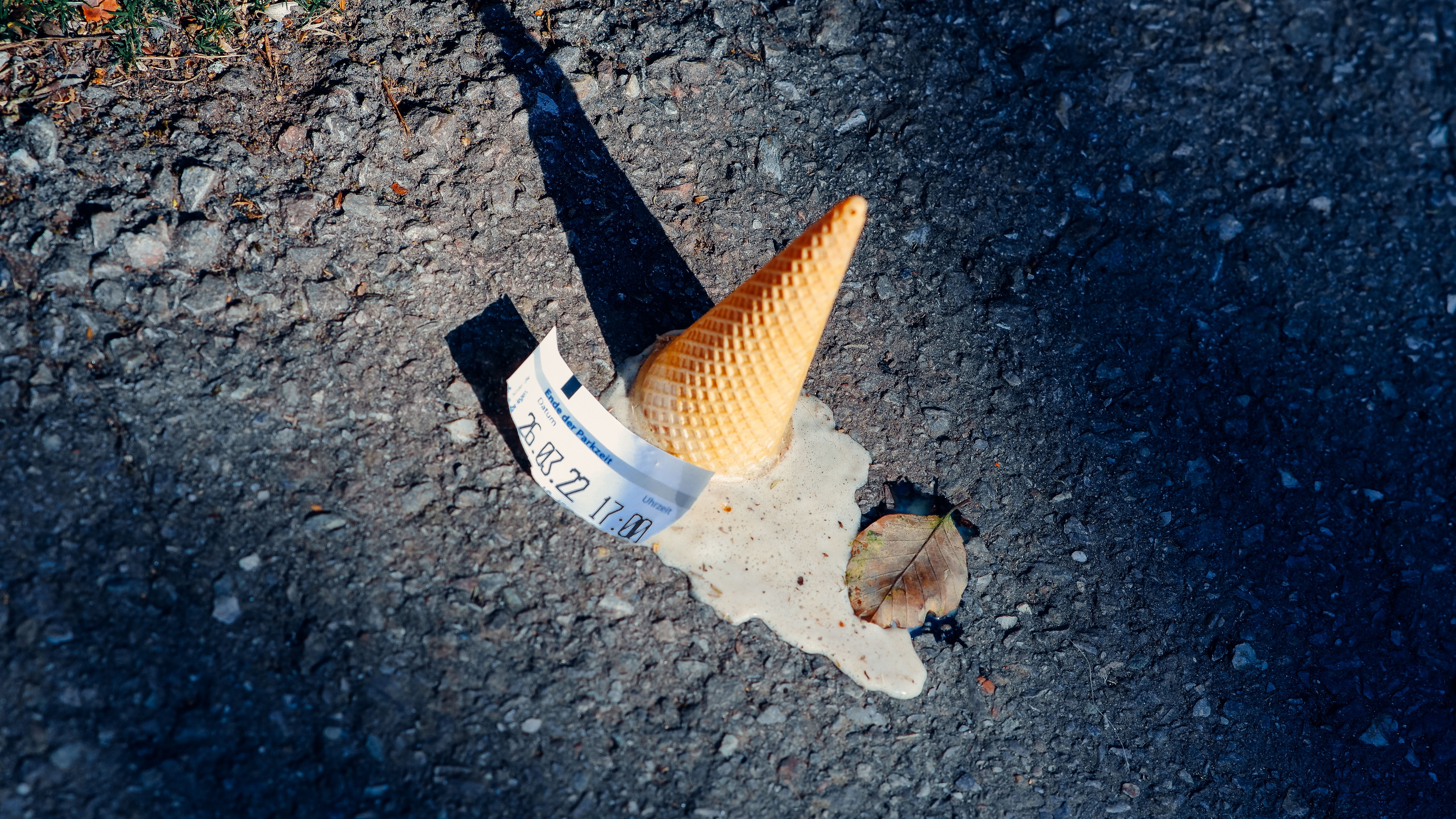 Fallen Ice Cream Cone on Asphalt Surface · Free Stock Photo
