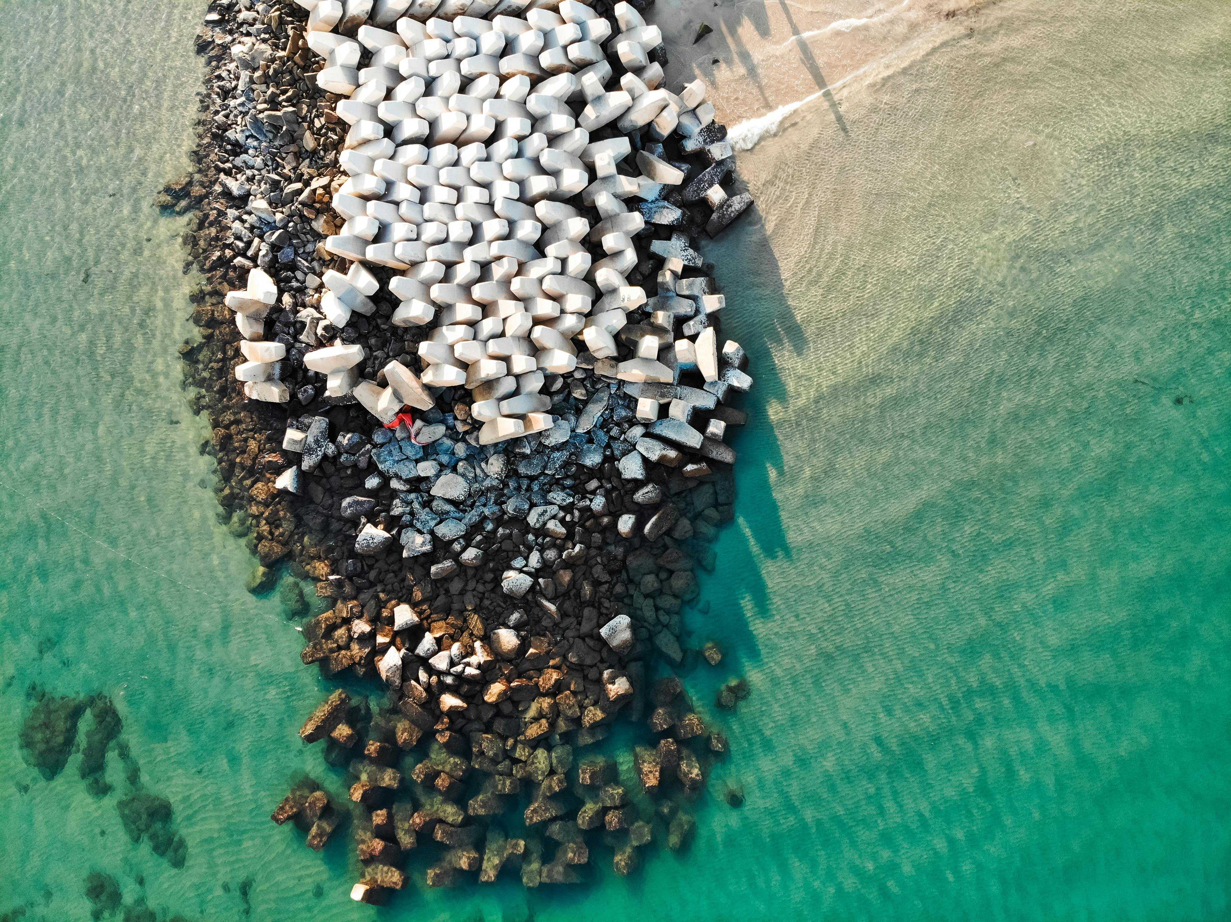 Aerial View of Breakwater Structures at Seaside · Free Stock Photo