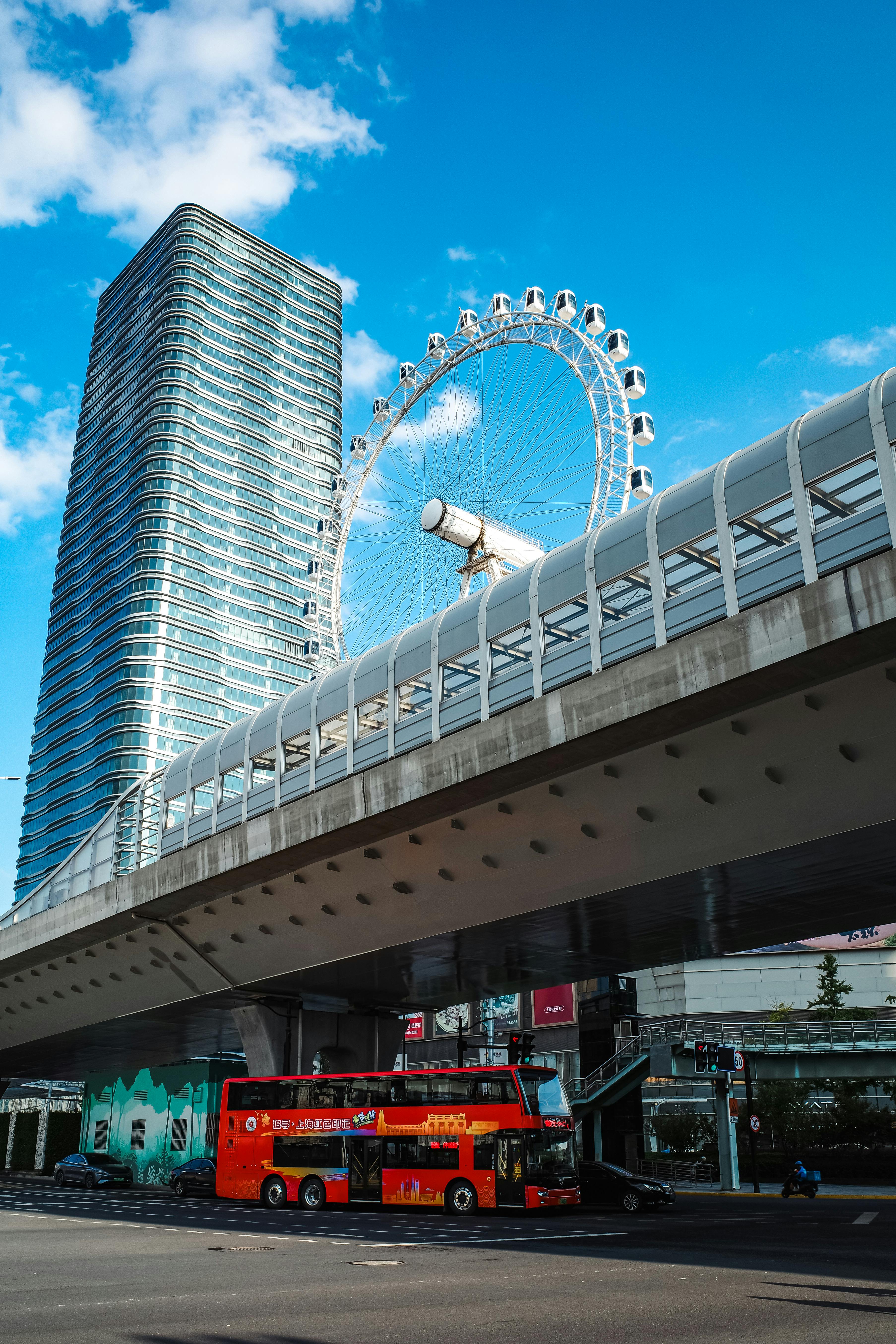 Red Tour Bus under Ferris Wheel on Sunny Day · Free Stock Photo