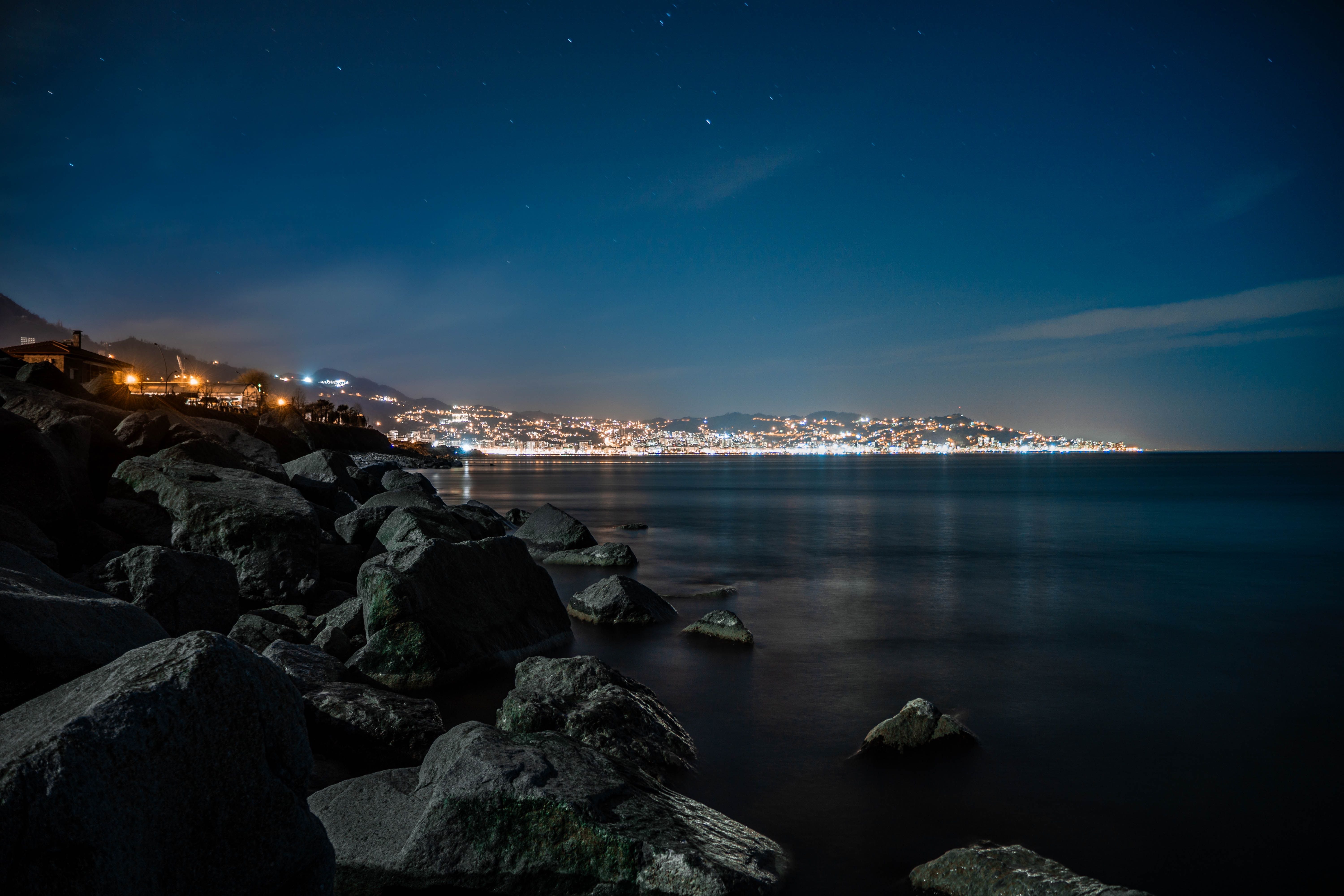 Scenic Night View of Coastal City Lights · Free Stock Photo