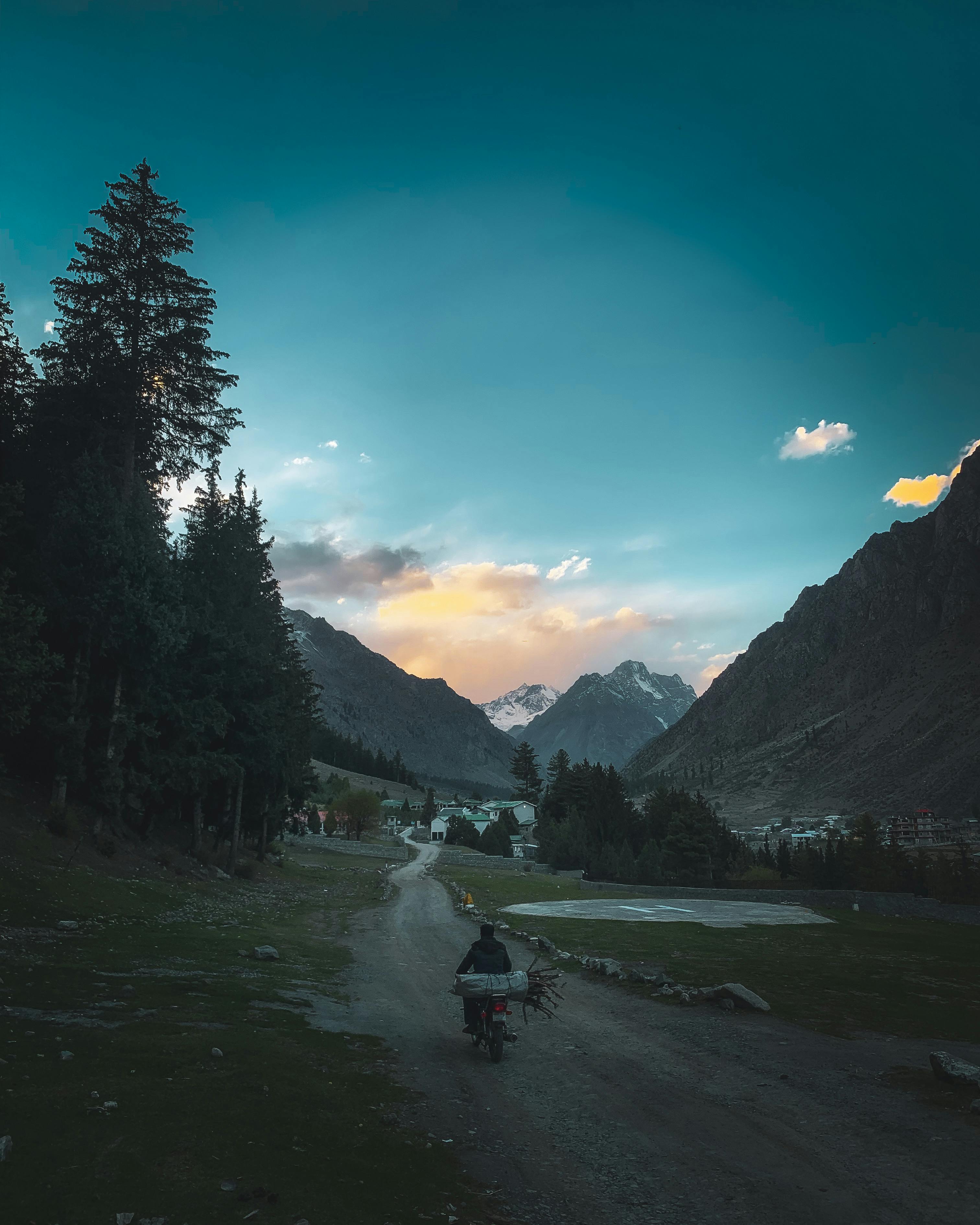 Scenic Motorcycle Ride Through Mountain Valley · Free Stock Photo