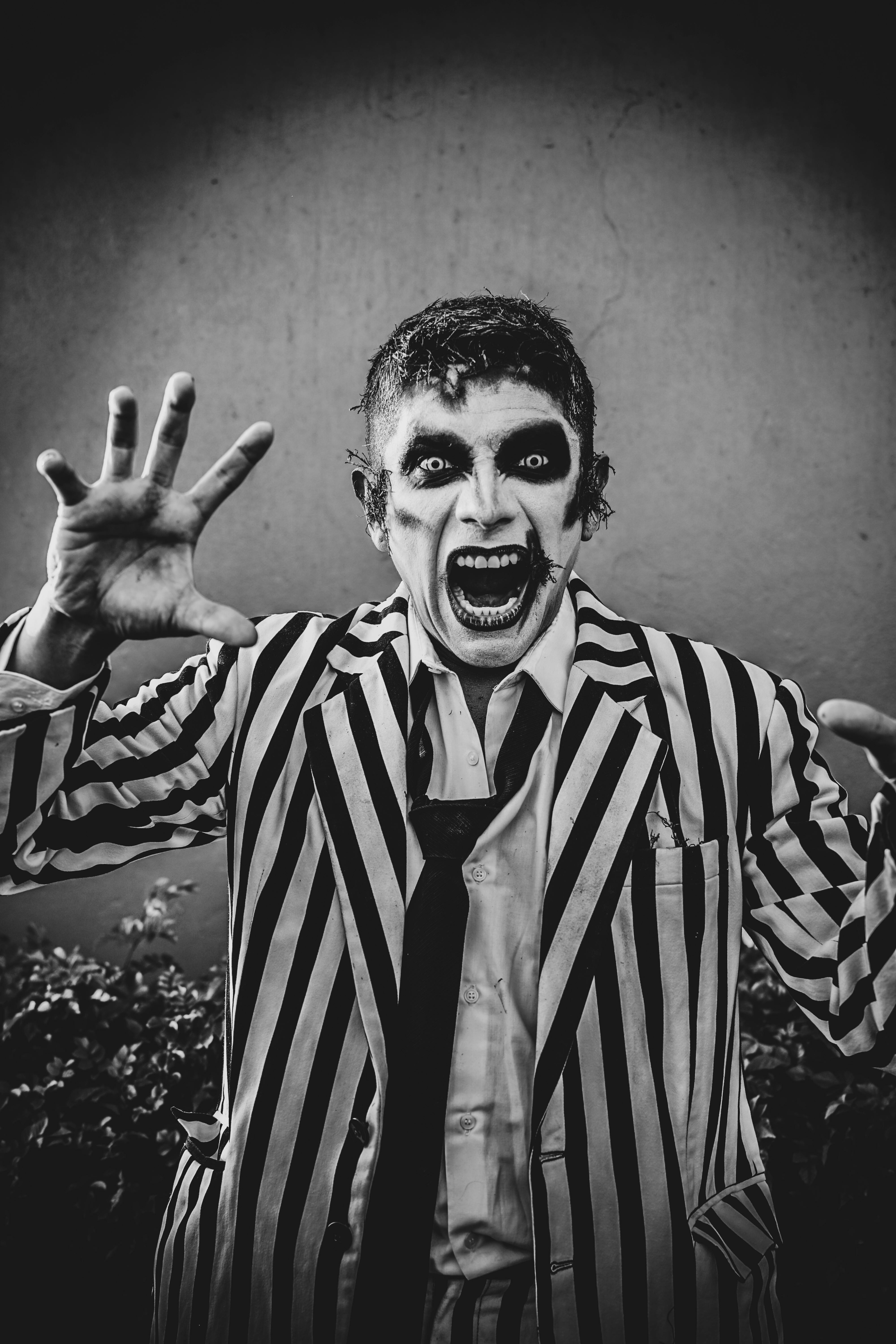 Frightening Clown in Striped Suit Portrait · Free Stock Photo