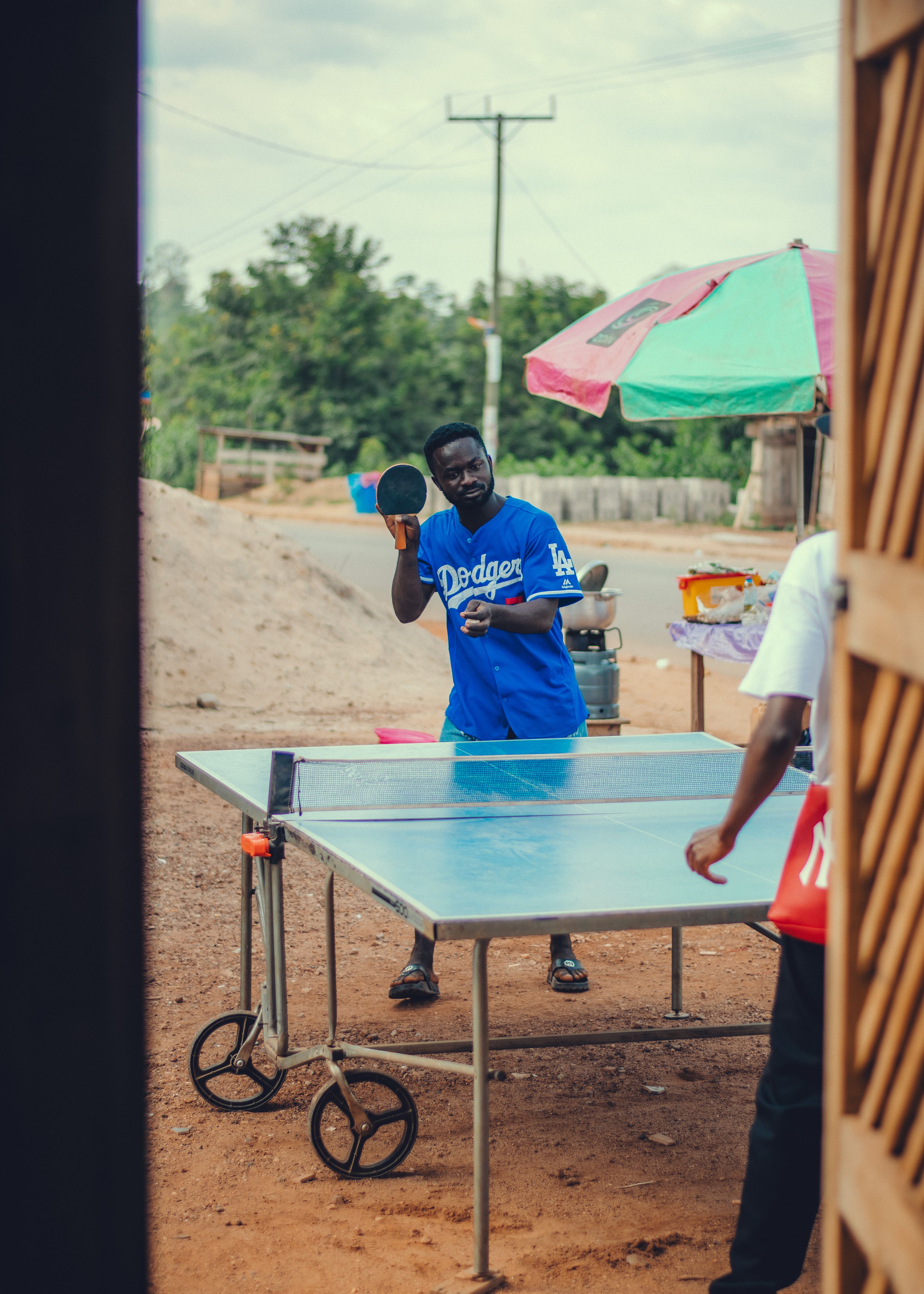 Outdoor Table Tennis Match in a Rural Setting · Free Stock Photo