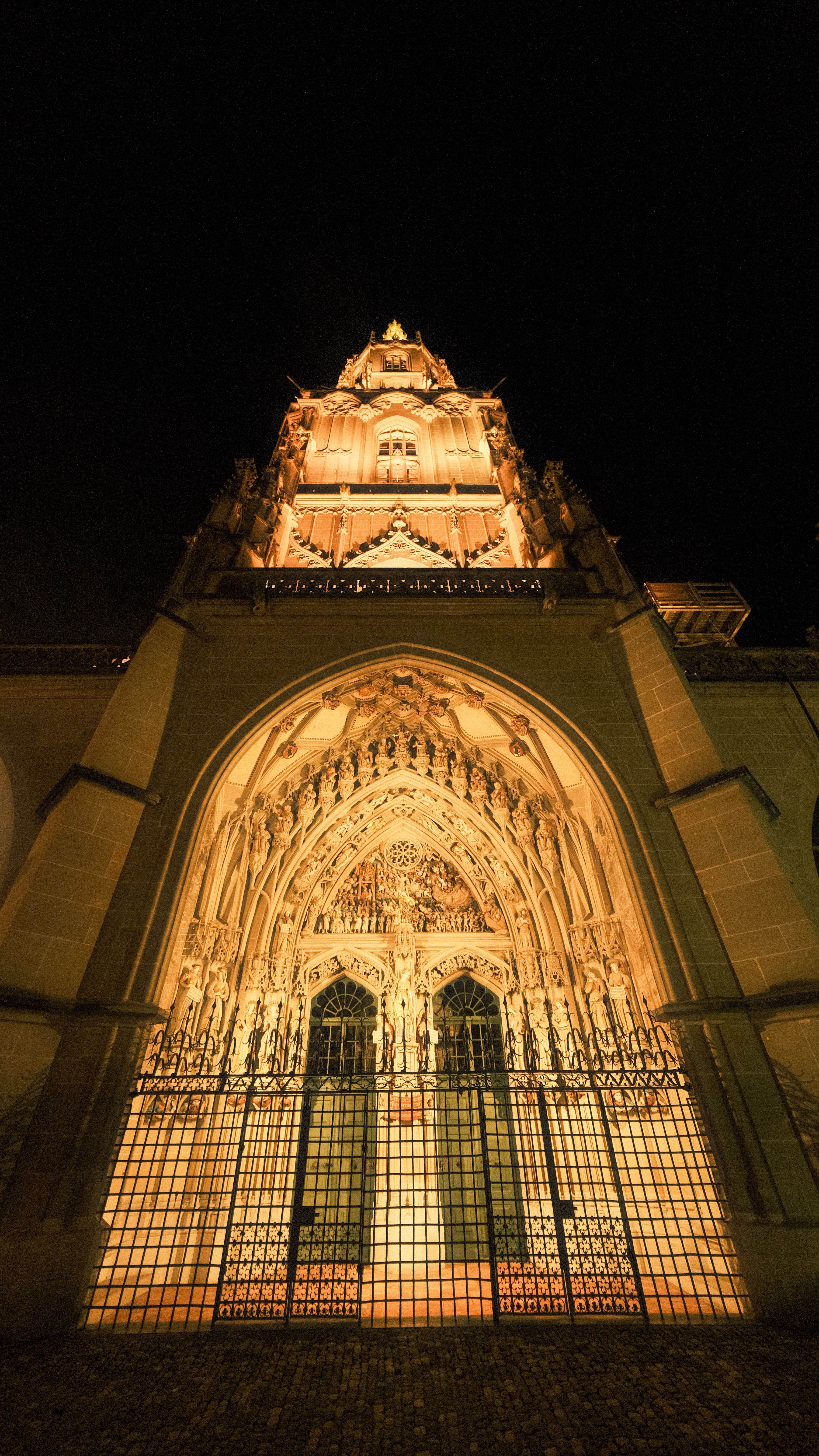 Illuminated Gothic Cathedral Facade at Night · Free Stock Photo