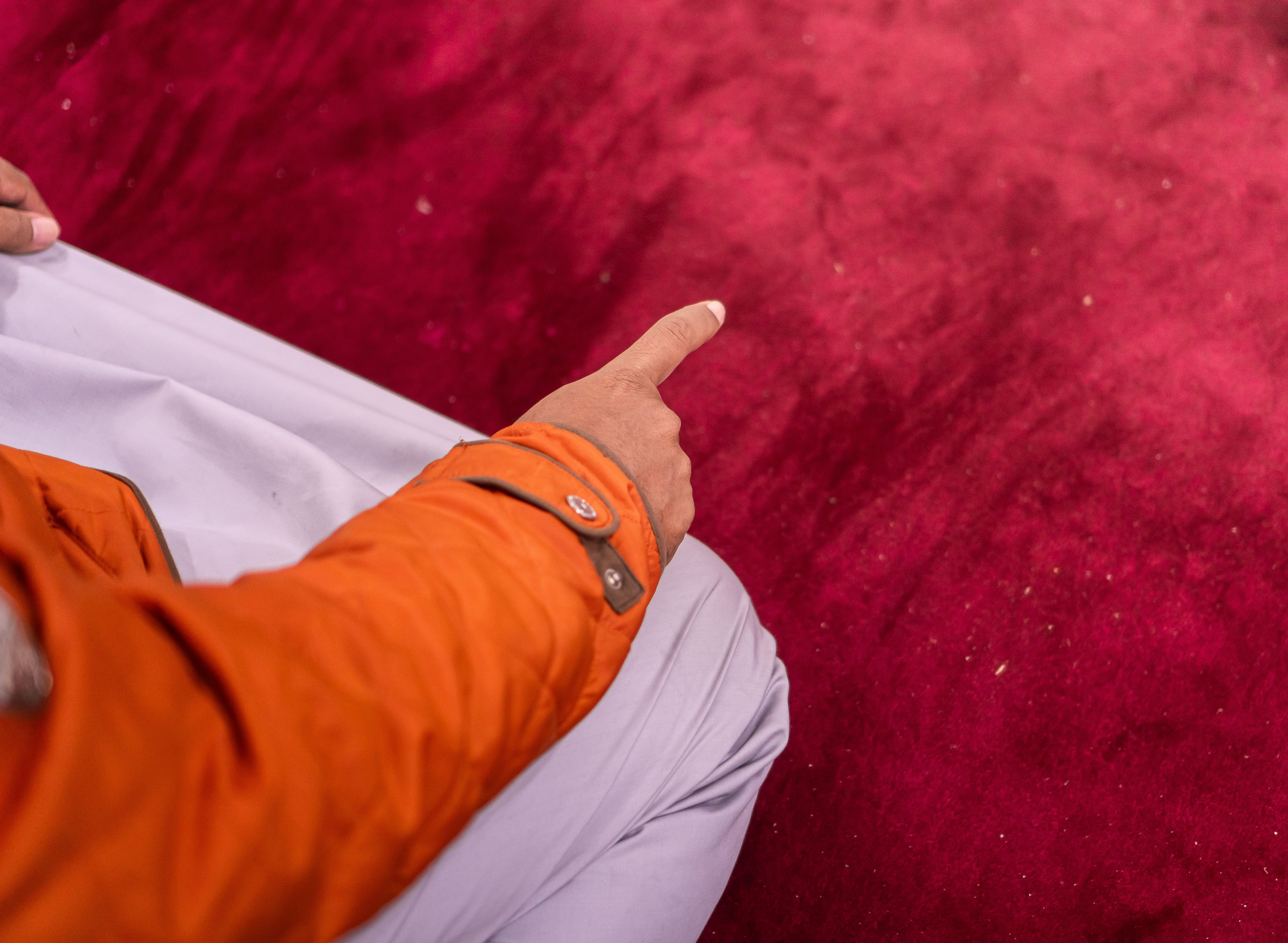 Individual Praying on Vibrant Red Carpet · Free Stock Photo