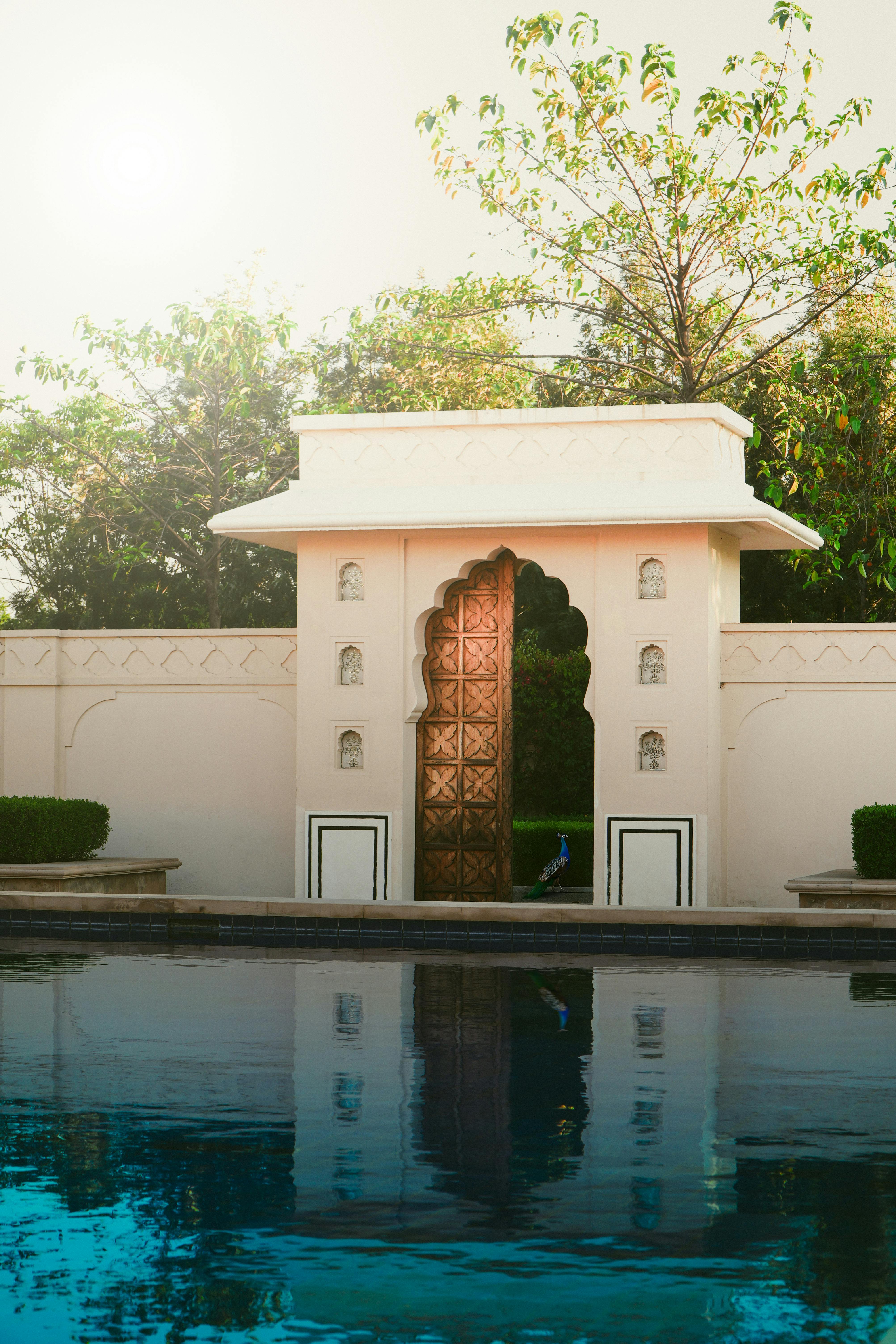 Elegant Traditional Archway by a Reflective Pool · Free Stock Photo