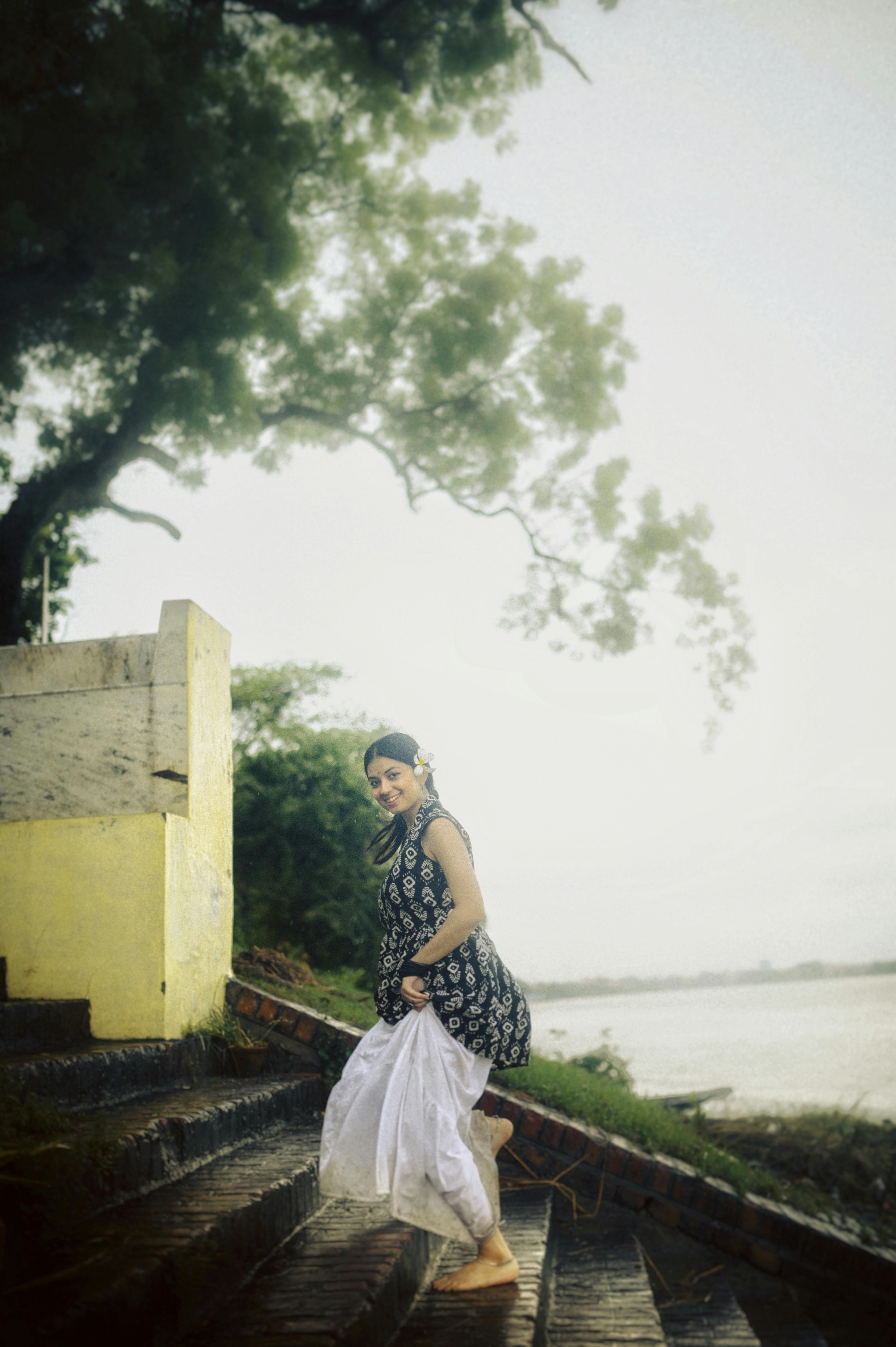 Serene Outdoor Portrait by Riverside Stairs · Free Stock Photo