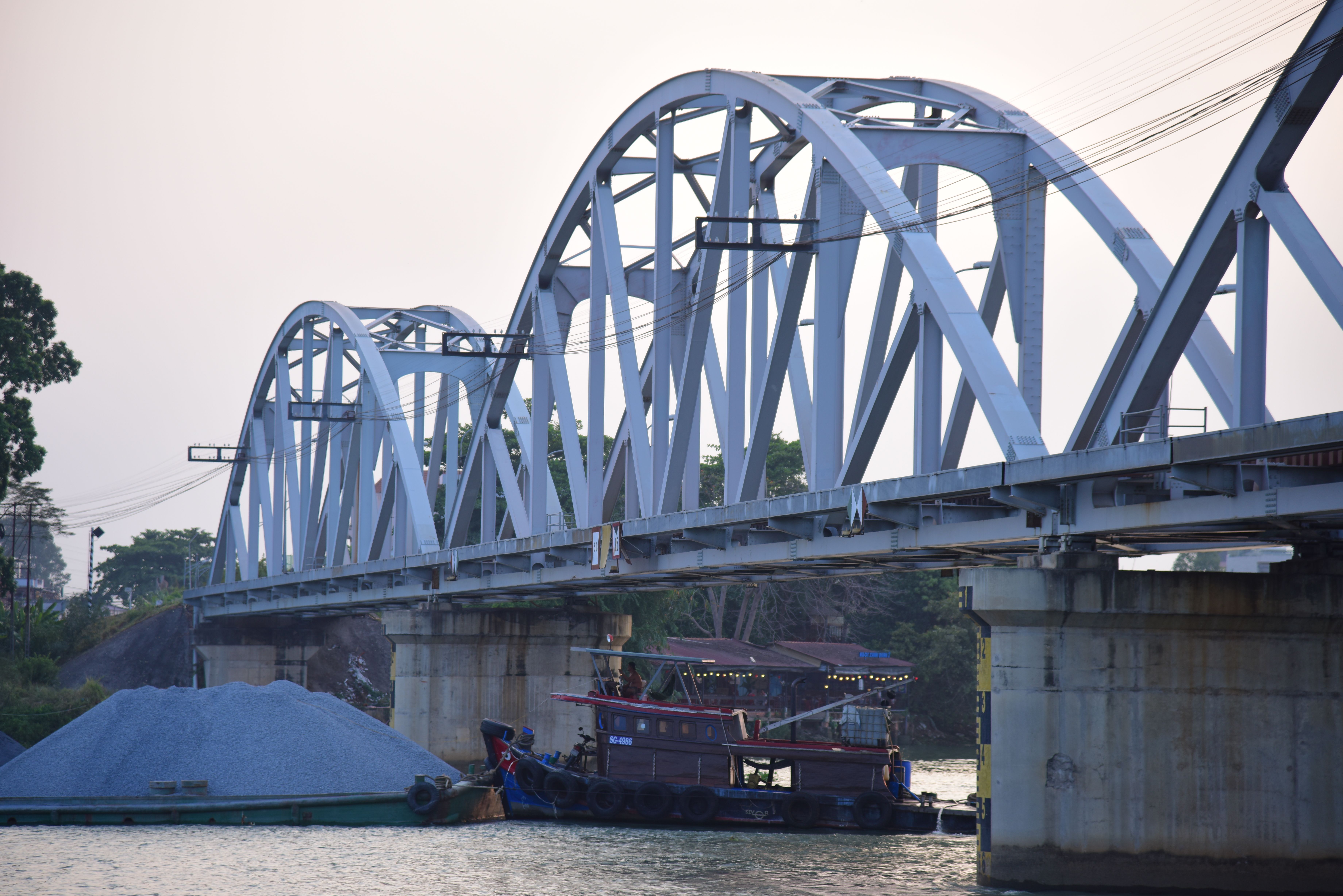 Scenic Bridge Over River with Industrial Boat · Free Stock Photo