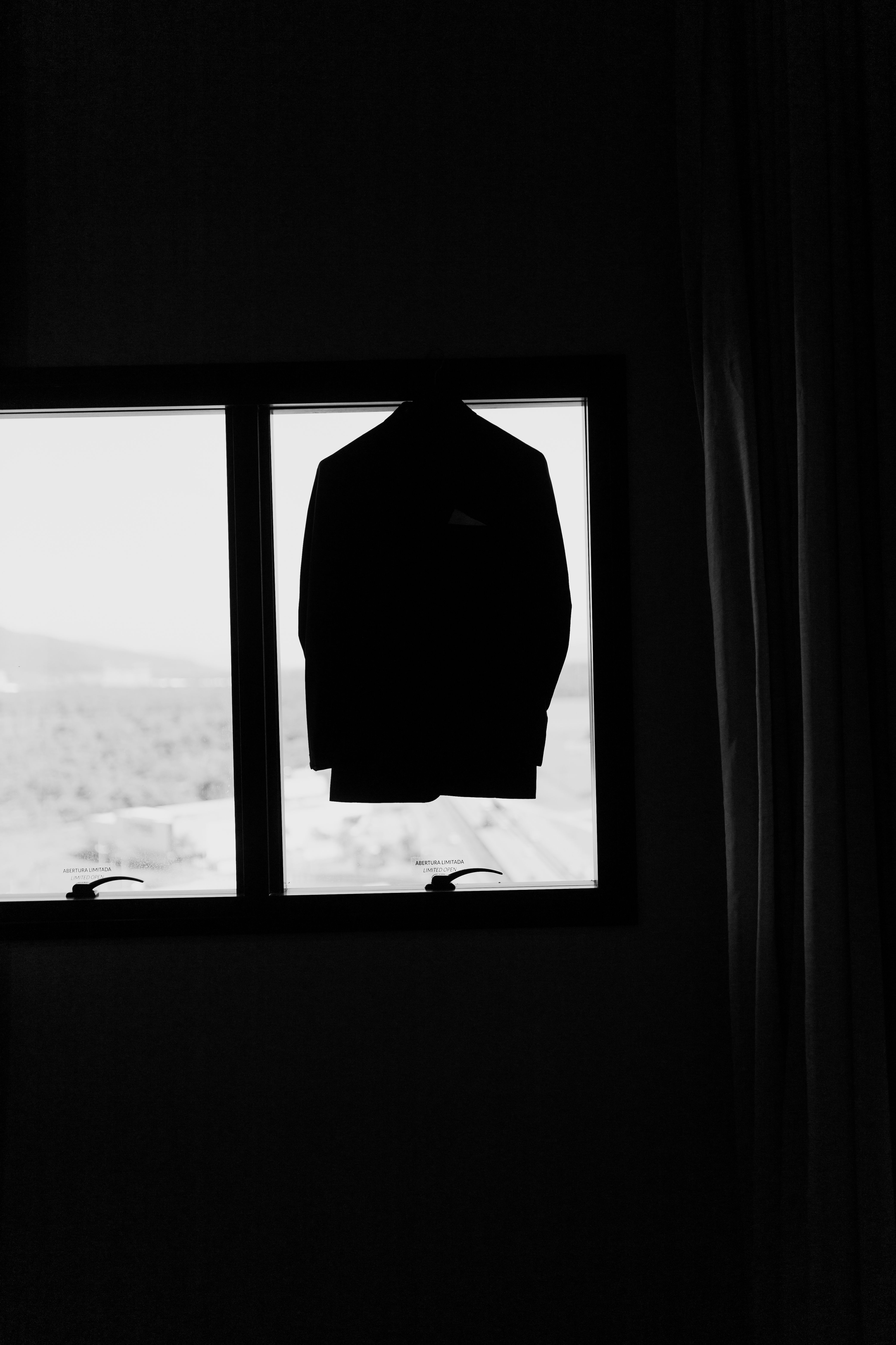 Black Suit Silhouette Hanging in Window · Free Stock Photo