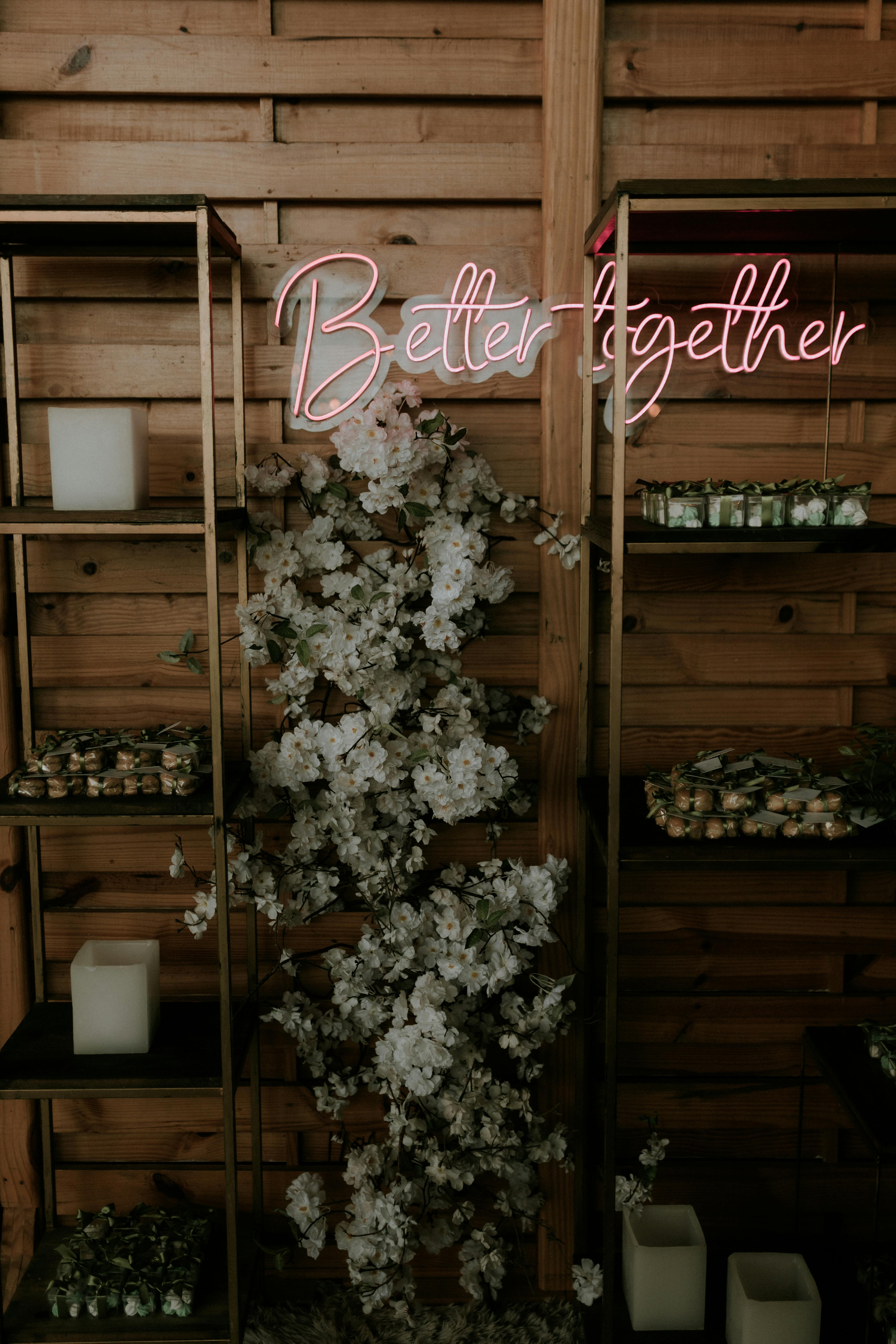 Rustic Wedding Decor with Neon Sign and Flowers · Free Stock Photo