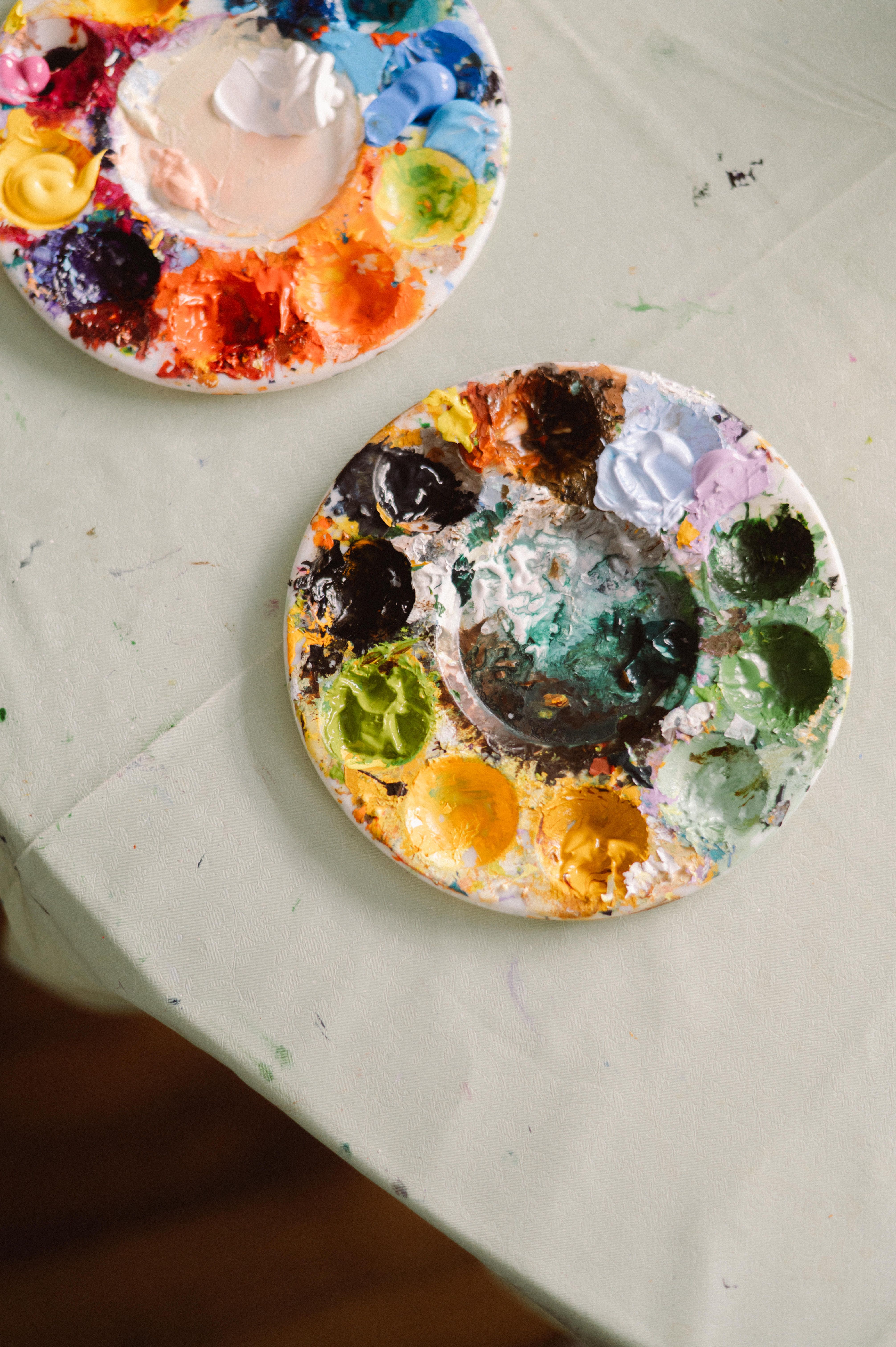 Colorful Artist Palettes on Creative Workspace · Free Stock Photo