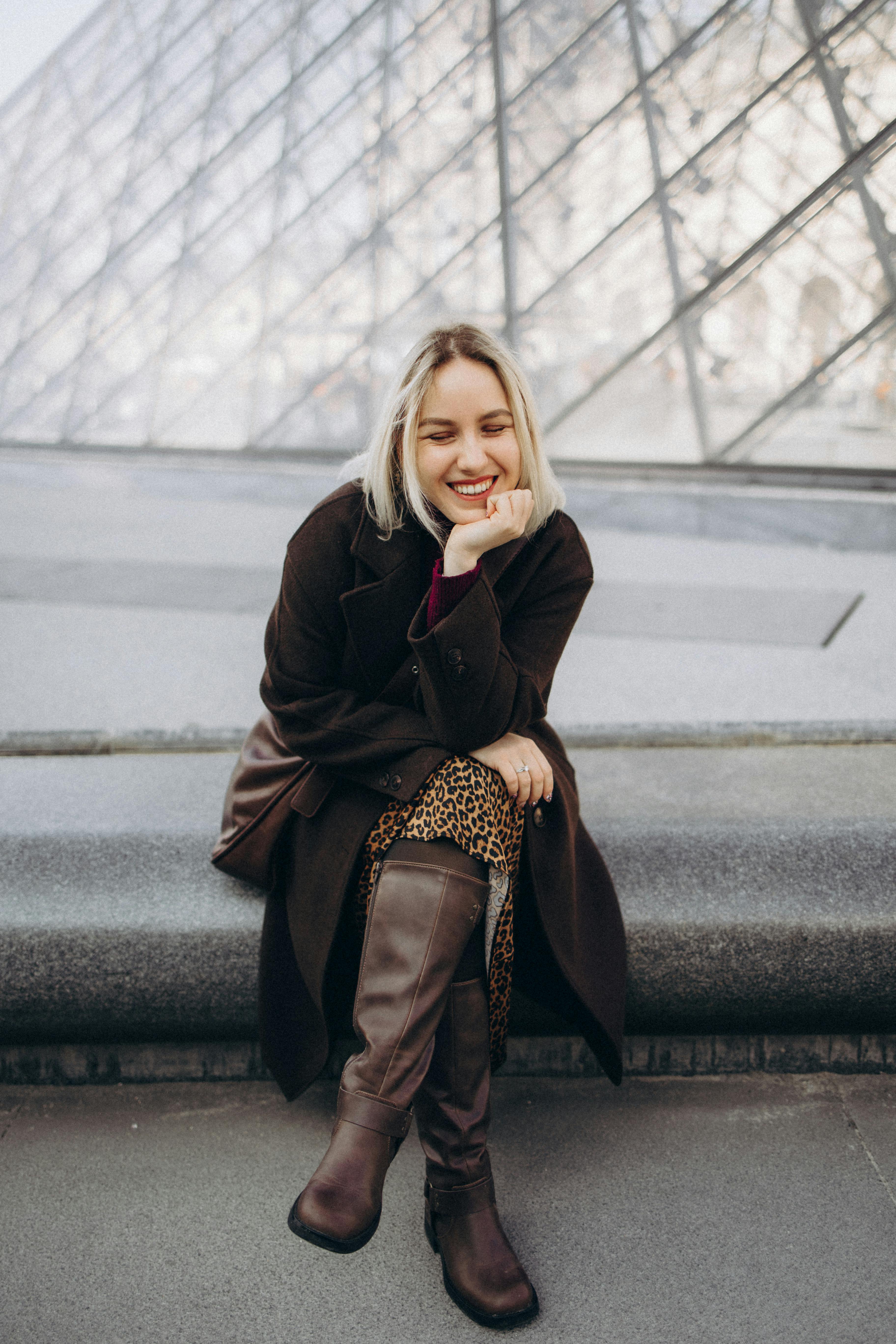Young Woman Smiling at the Louvre Pyramid · Free Stock Photo