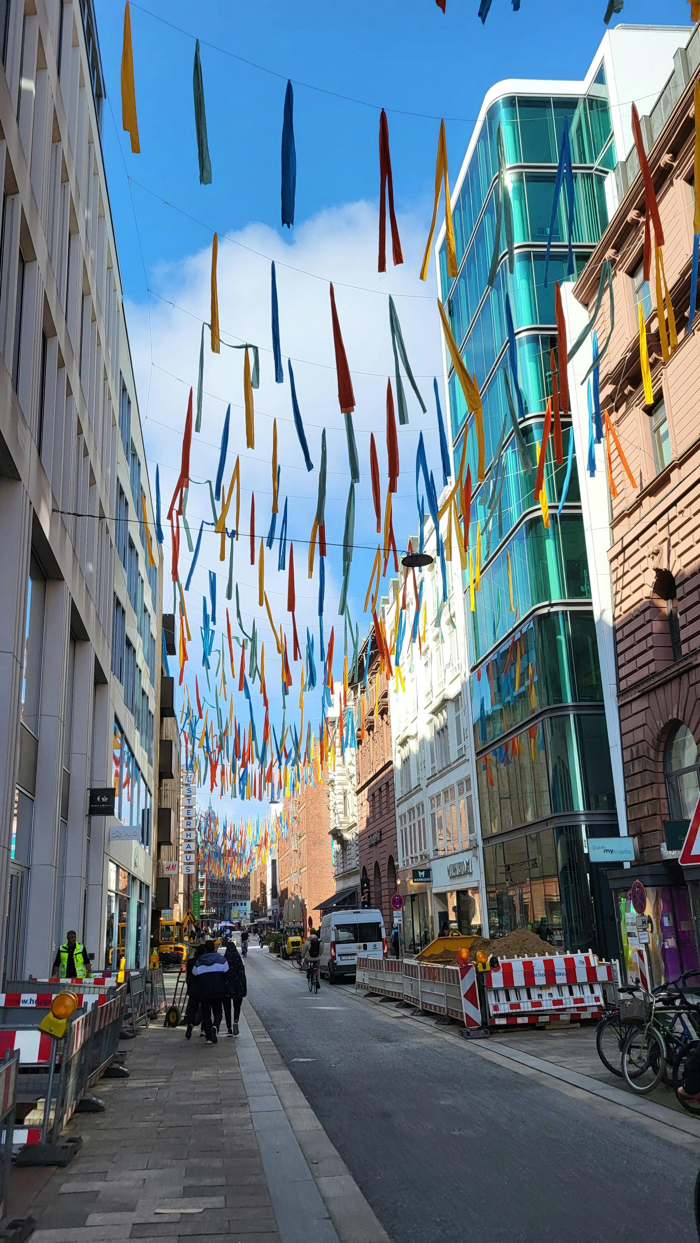 Colorful Street Scene with Flags in Urban Area · Free Stock Photo