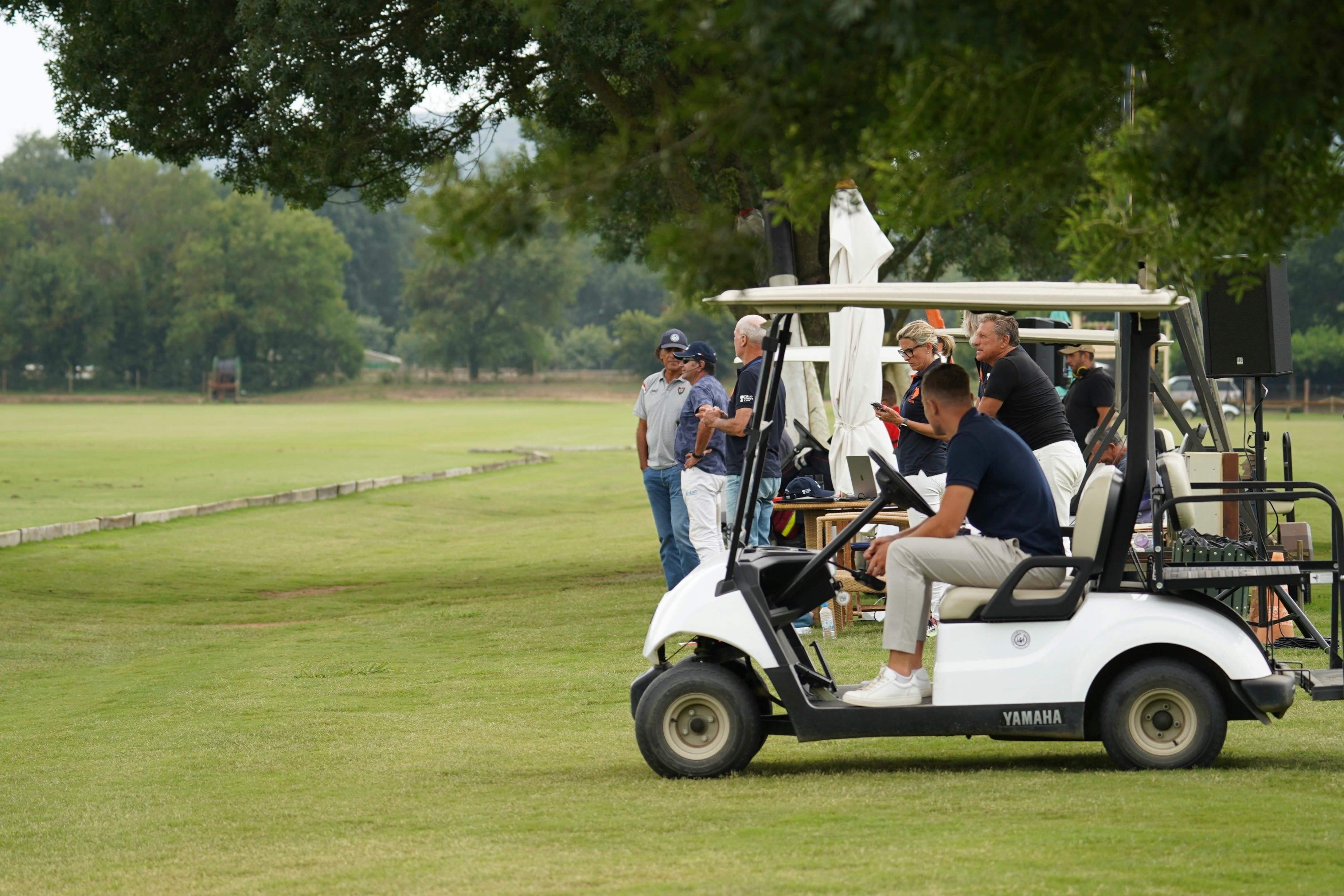 Golfers Relaxing on Golf Course in Carts · Free Stock Photo