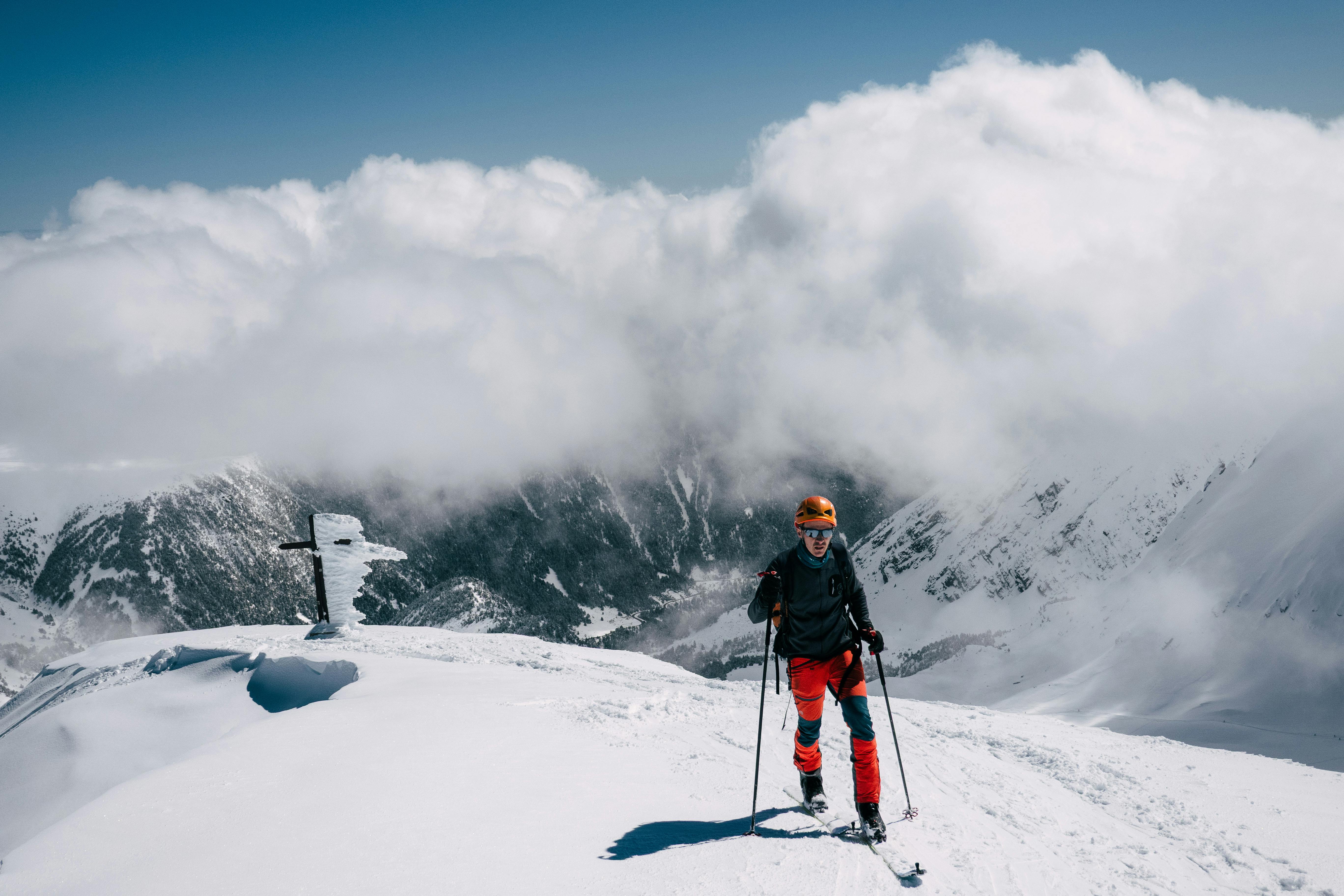 Adventurous Skier on Mountain Summit · Free Stock Photo