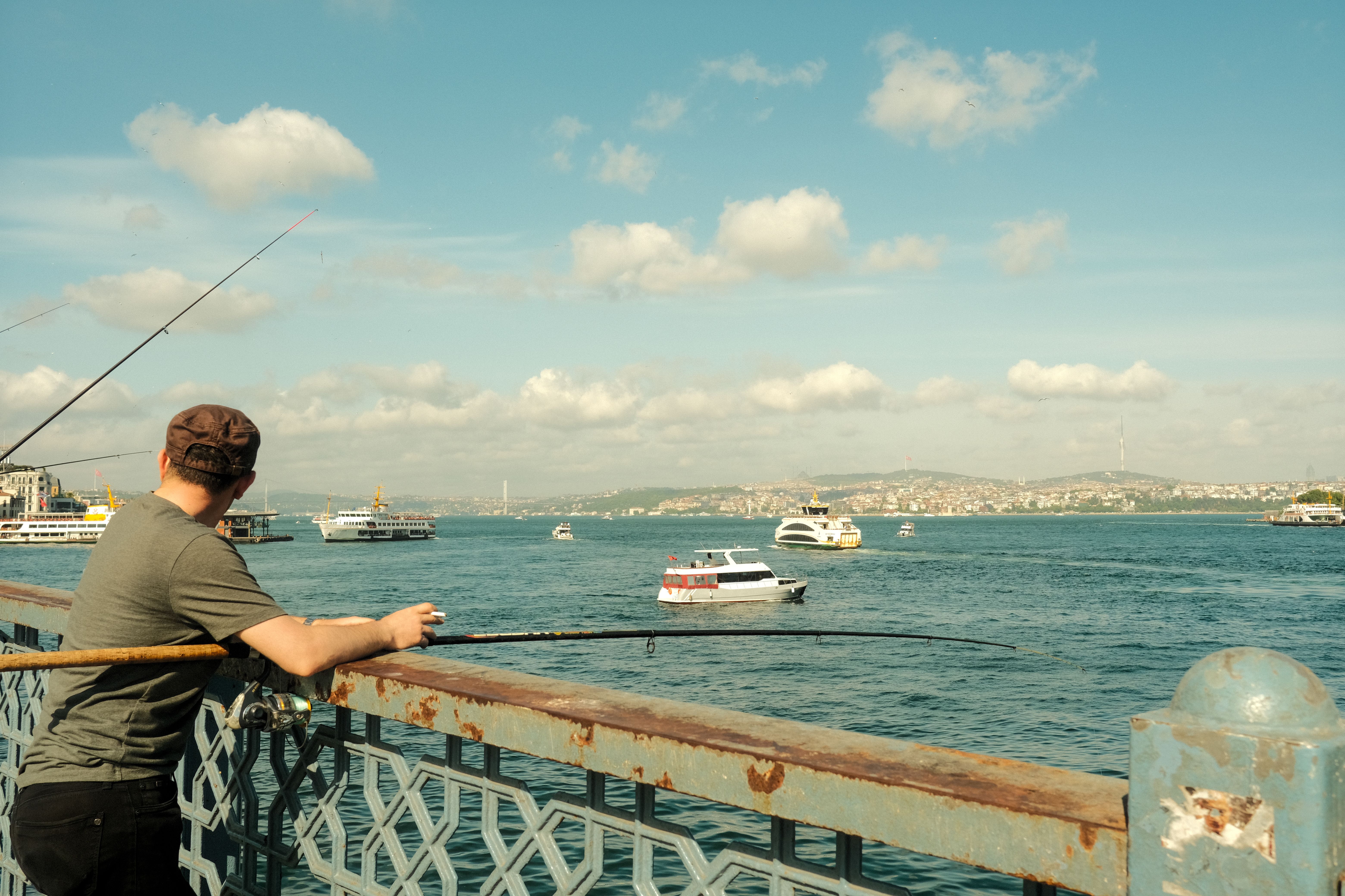 Fisherman on Galata Bridge Overlooking Bosphorus · Free Stock Photo