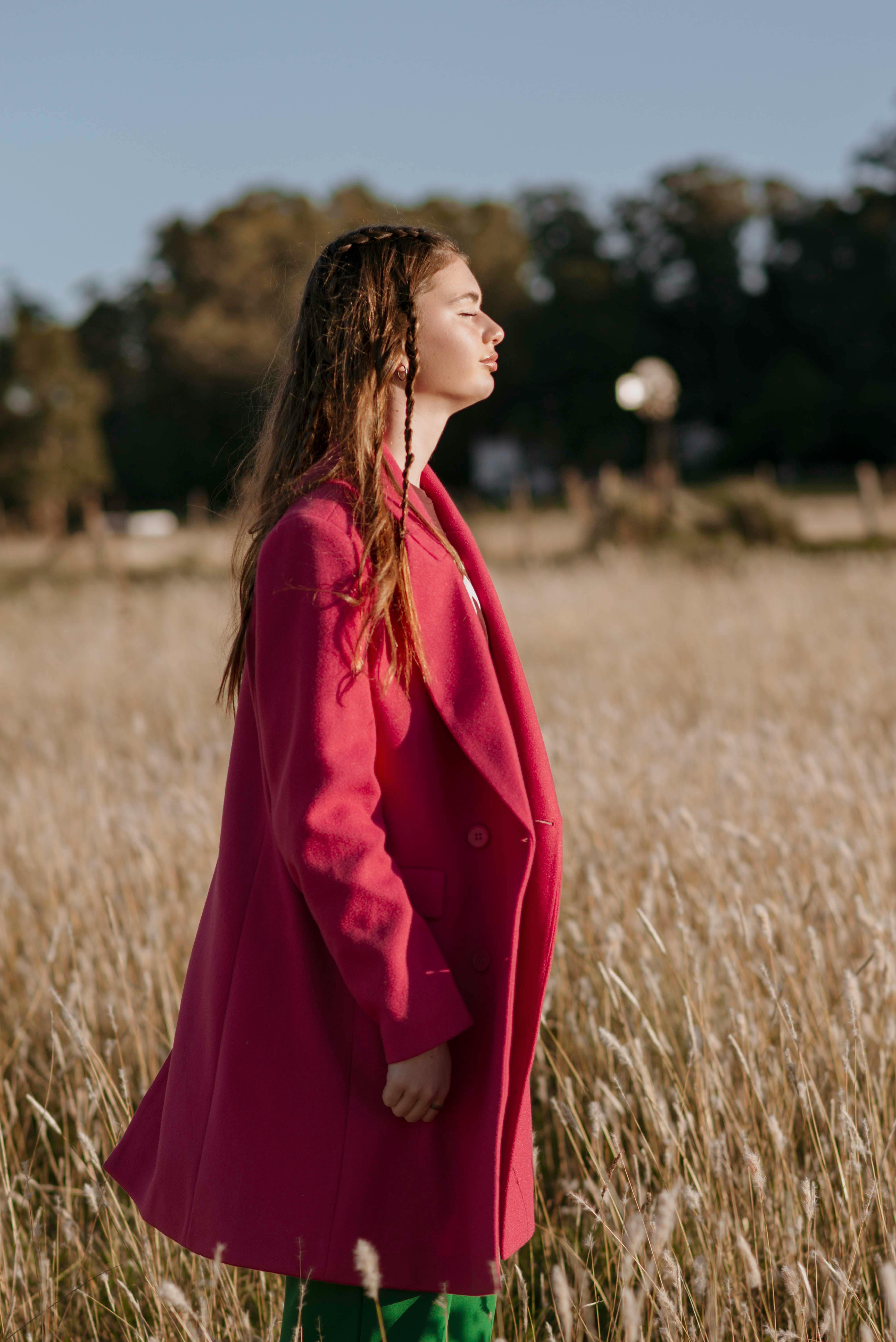 Side Profile of Woman in Pink Coat Outdoors · Free Stock Photo
