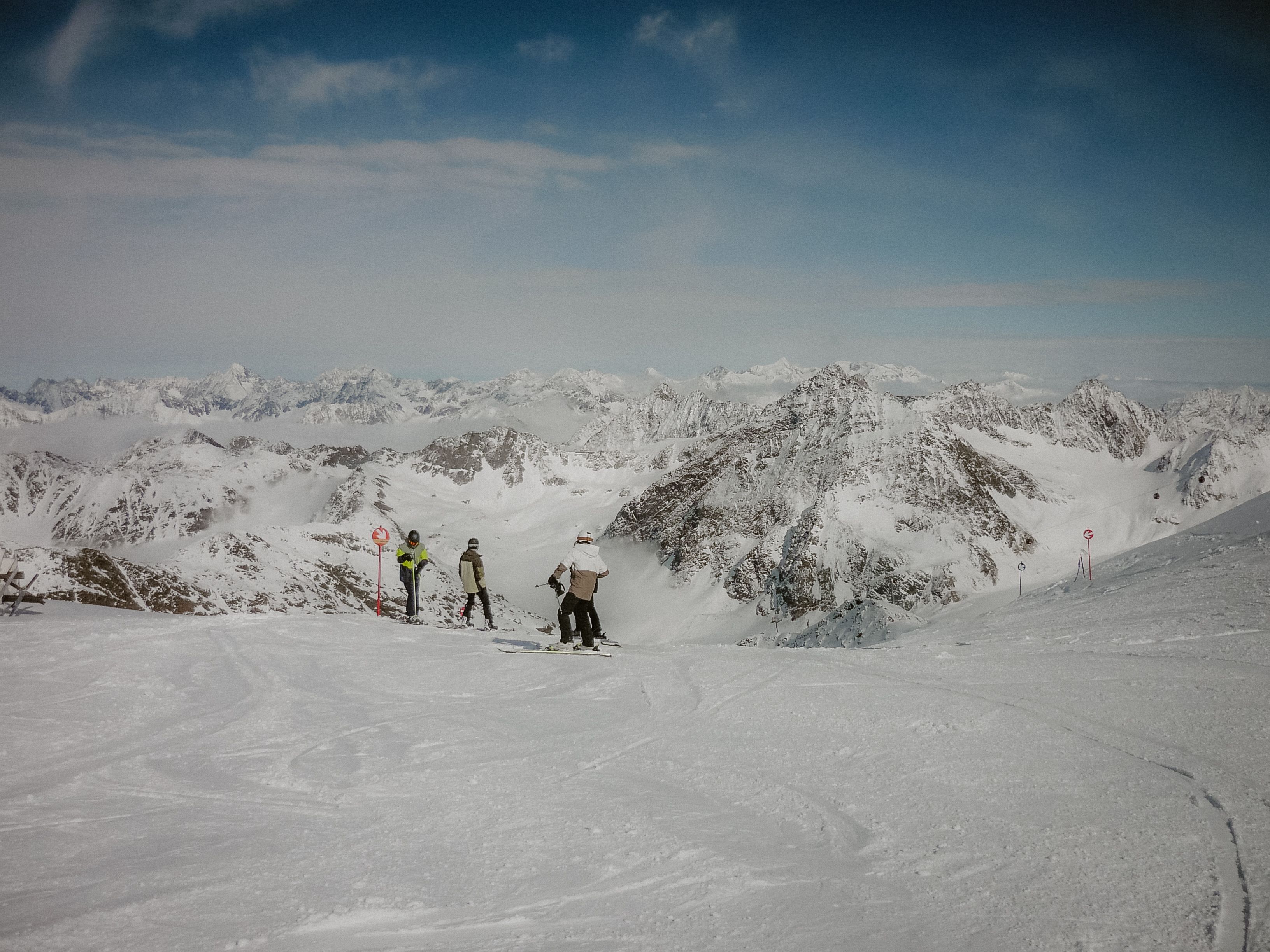Skiers Enjoying Scenic Alpine Snowy Mountain View · Free Stock Photo