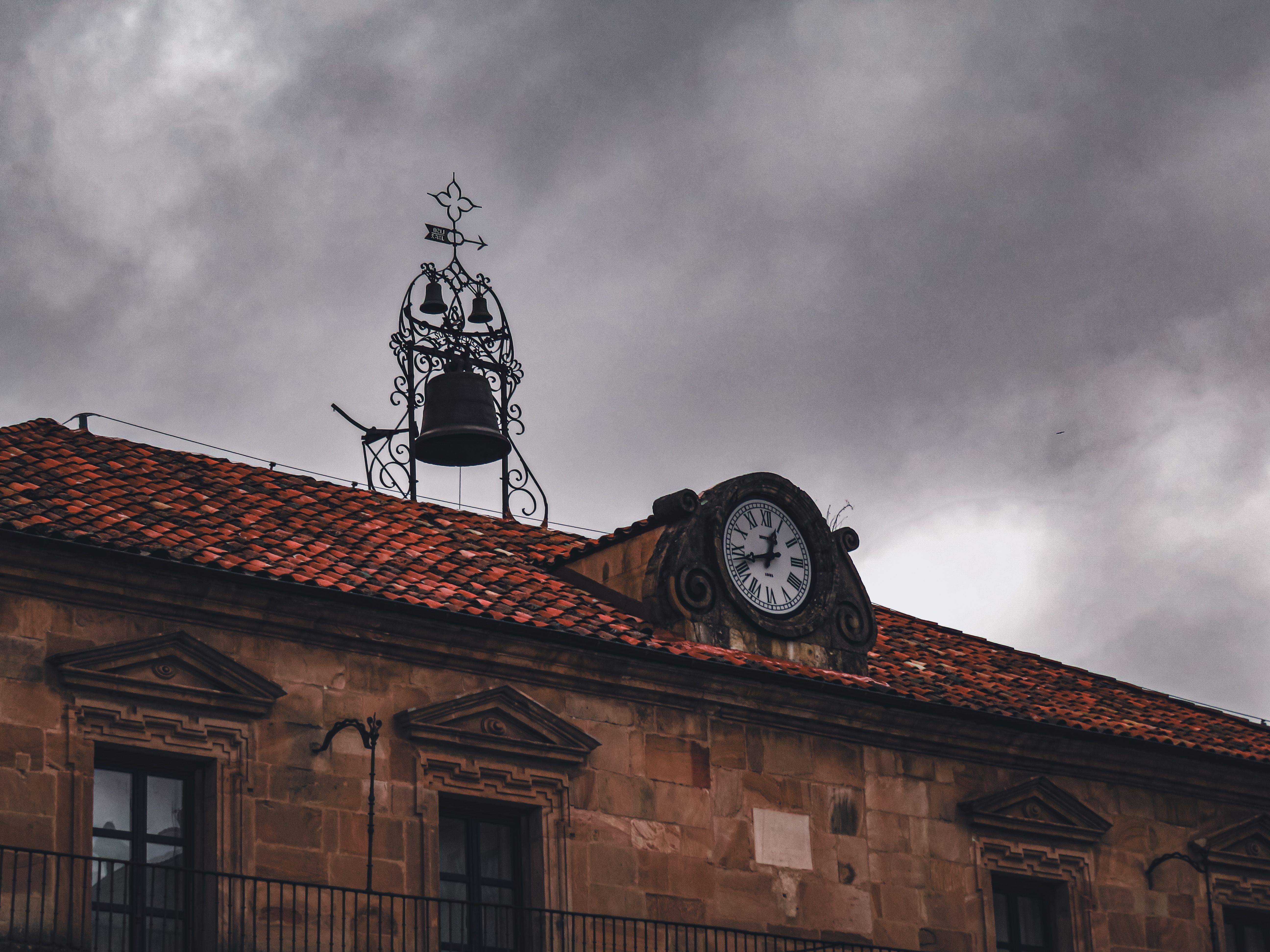 Classic Building Facade with Clock Tower and Bell · Free Stock Photo