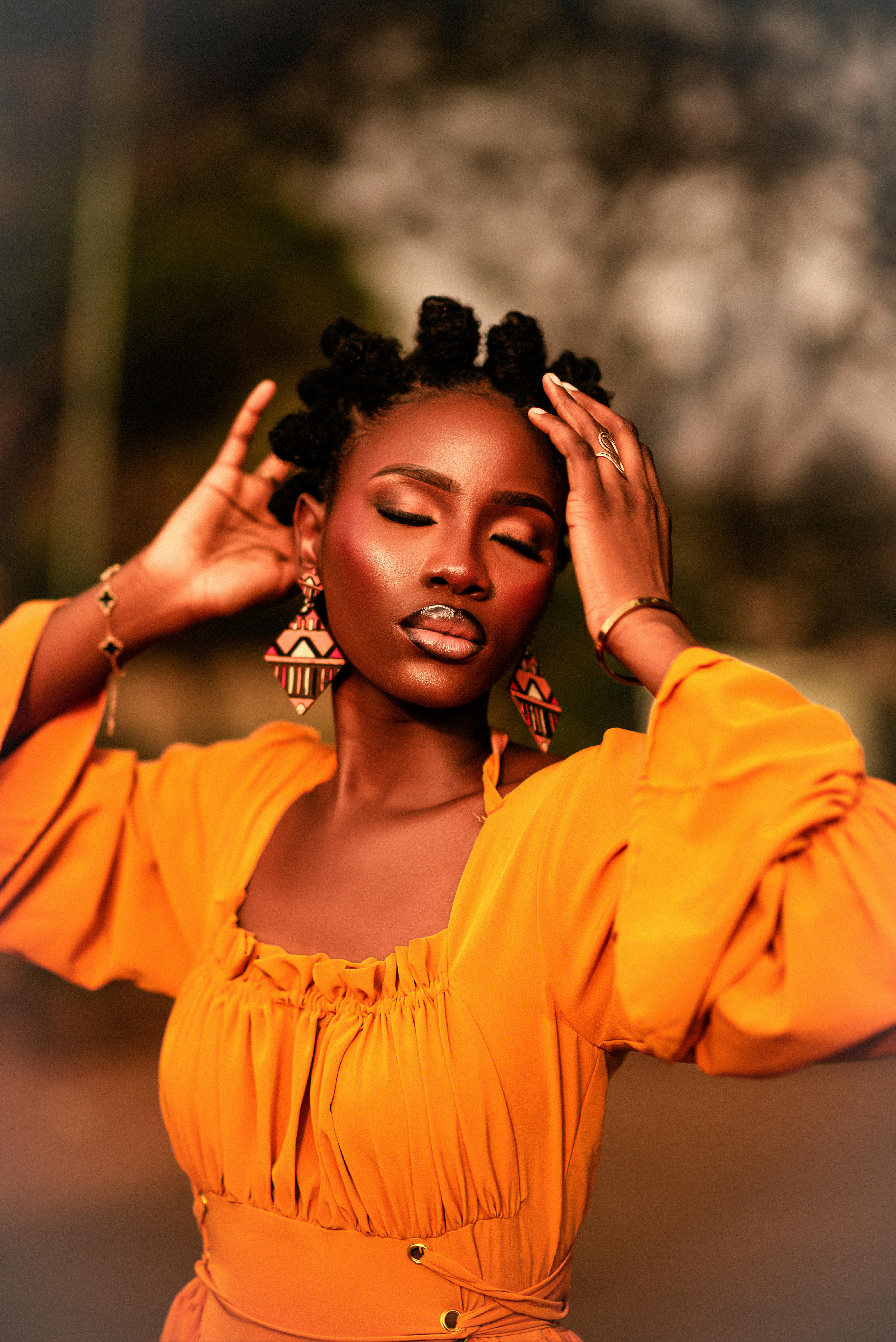 Elegant Portrait of Woman in Bright Orange Dress · Free Stock Photo