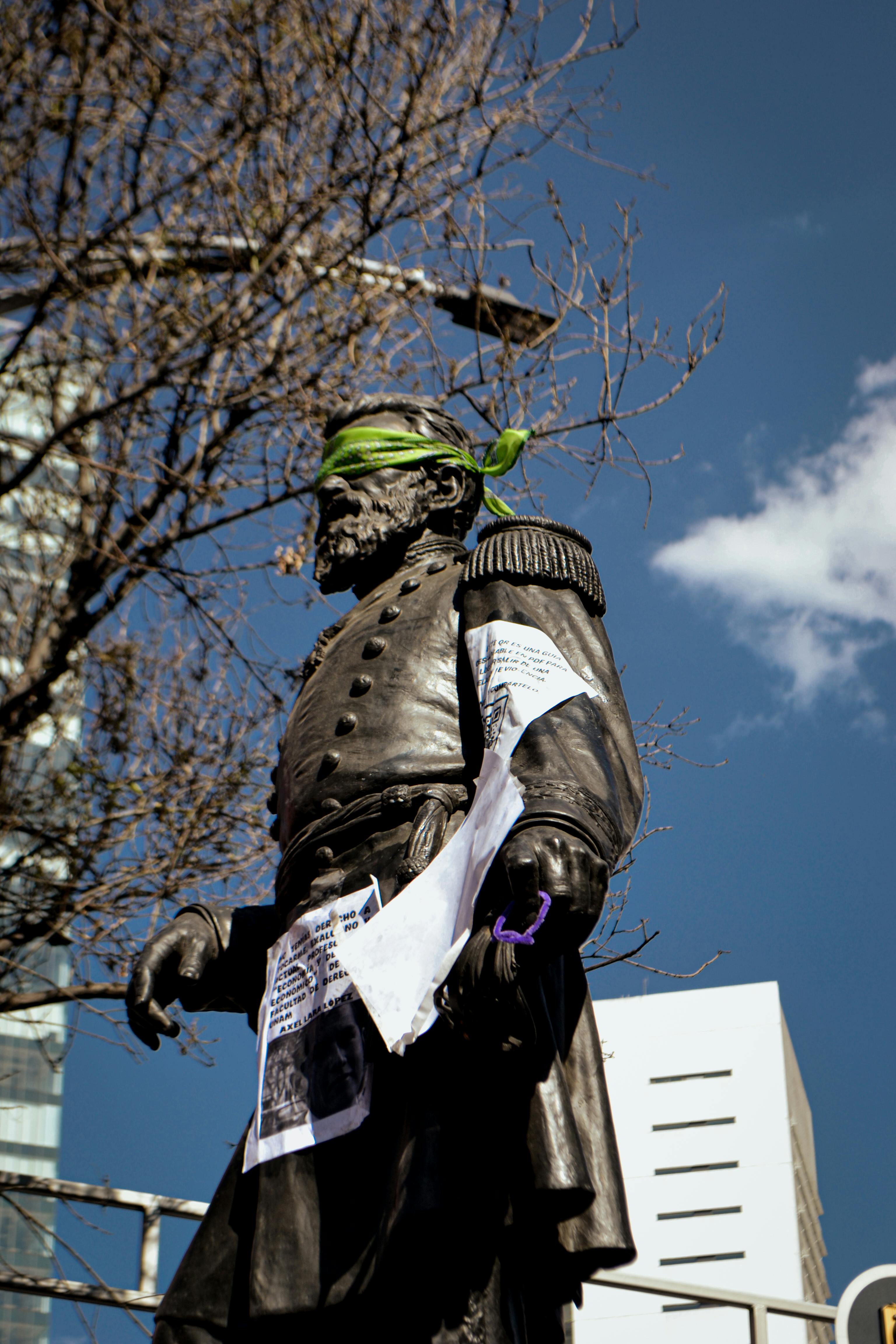 Statue Covered in Protest Materials Outdoors · Free Stock Photo