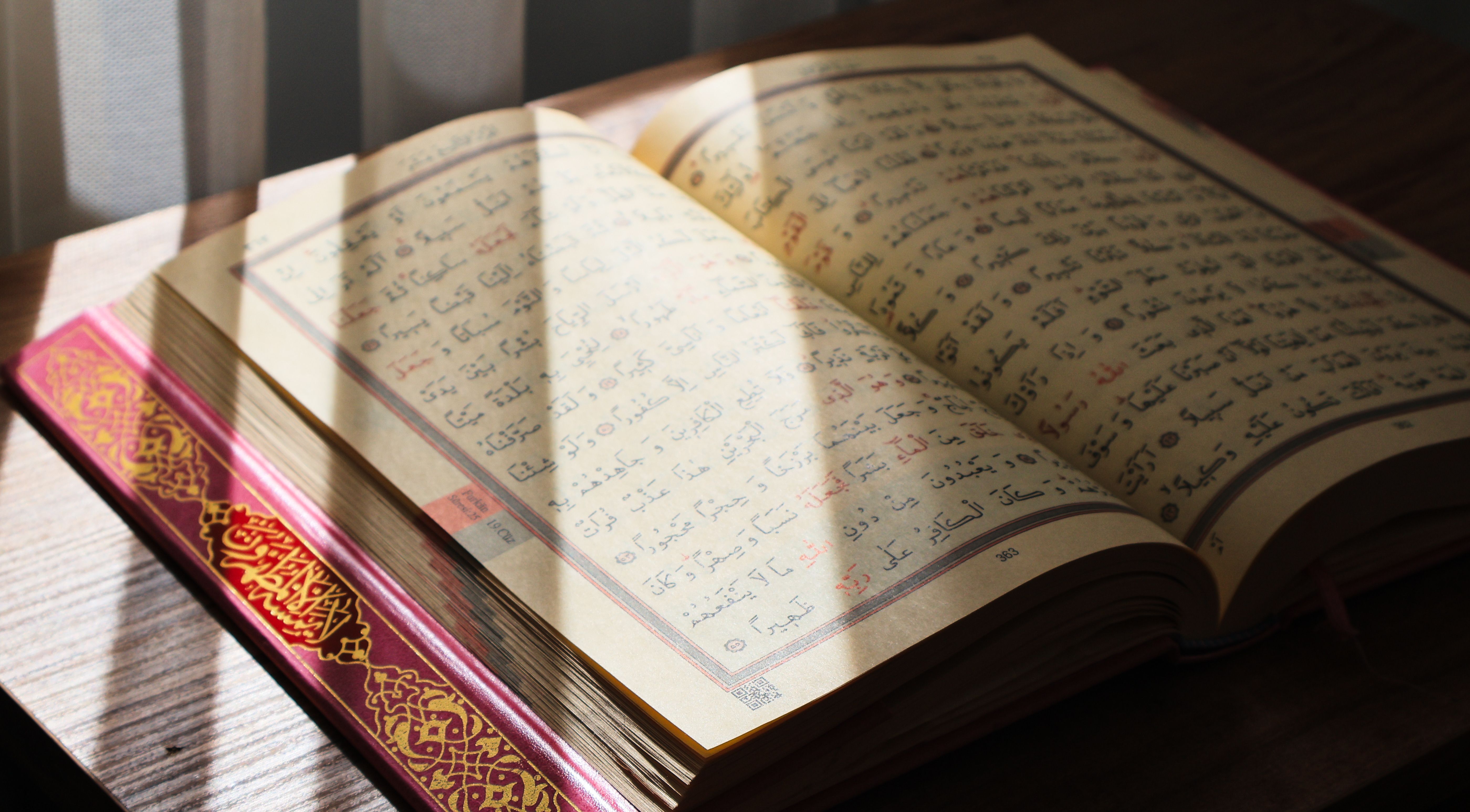 Open Quran on Wooden Table with Sunlight · Free Stock Photo
