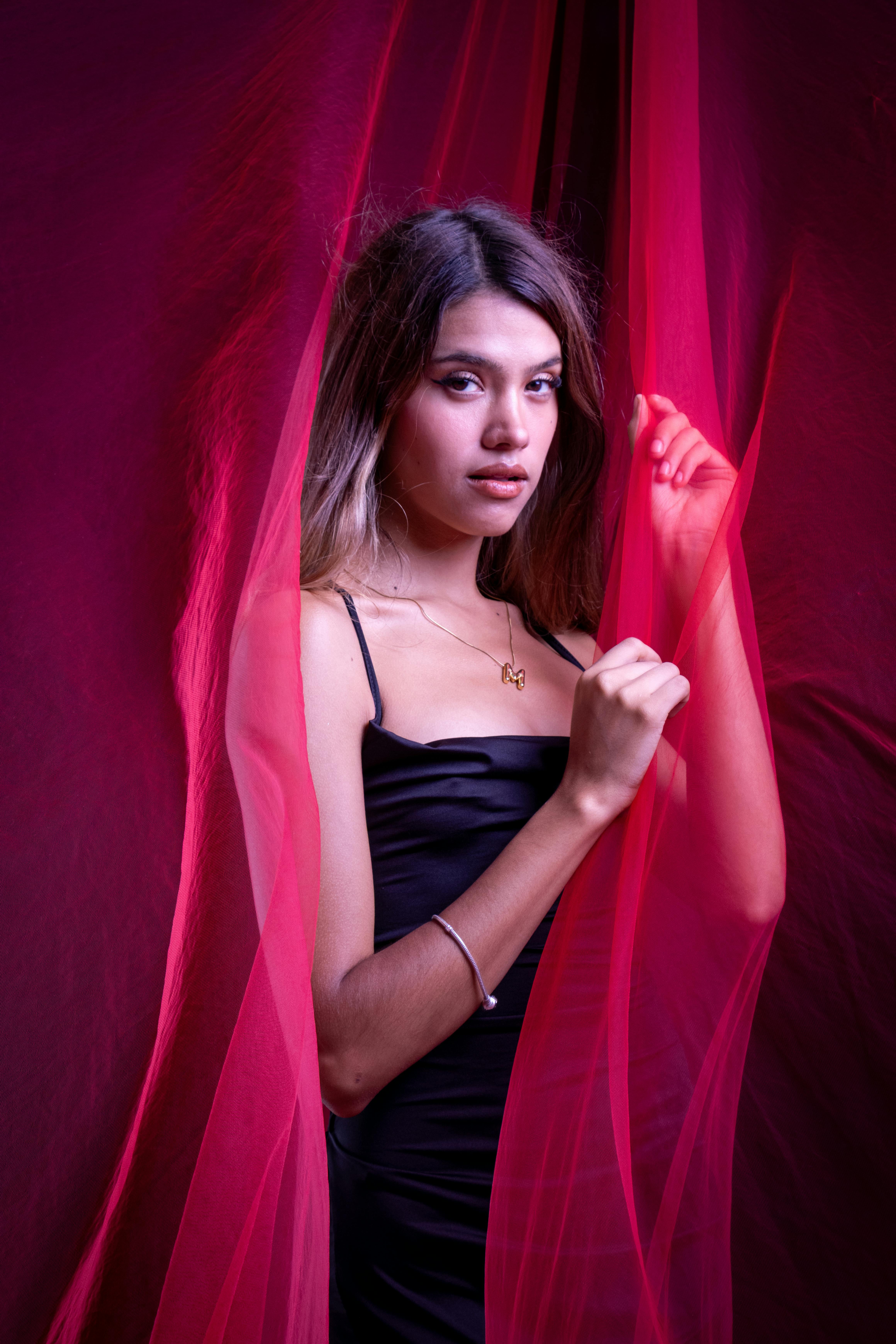 Elegant Portrait of Woman Behind Red Drapes · Free Stock Photo
