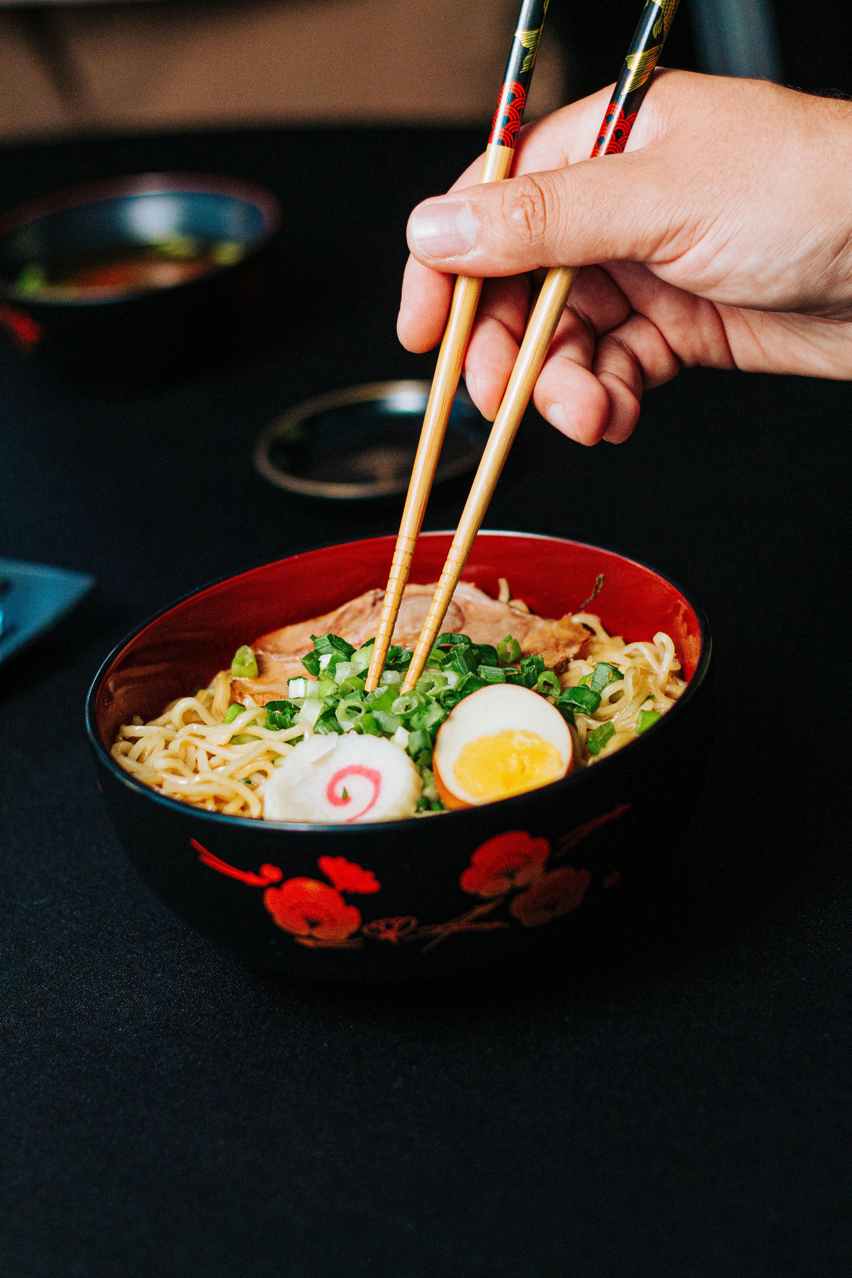 Japanese Ramen Bowl with Chopsticks on Sunlit Table · Free Stock Photo