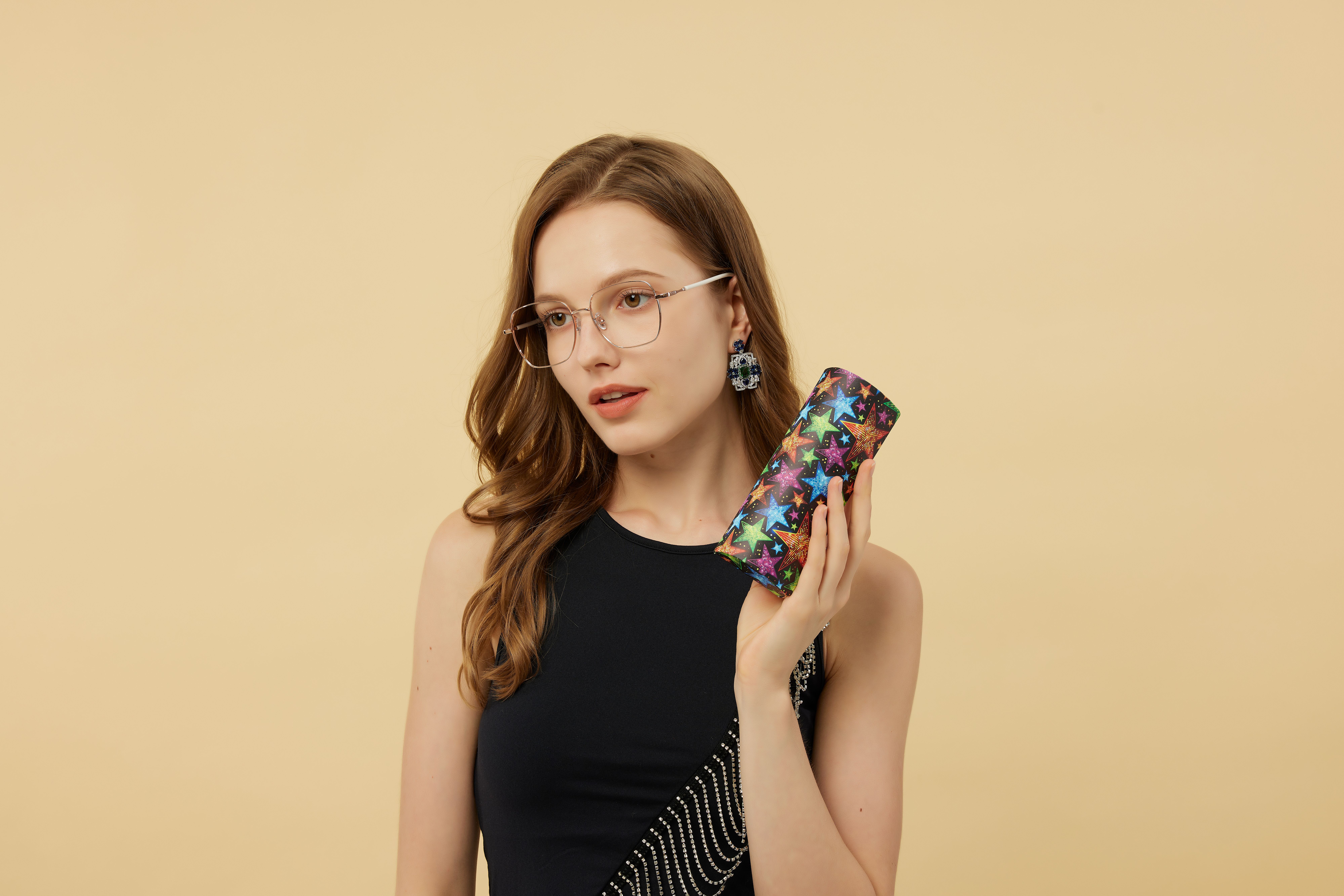 Elegant Woman Holding a Colorful Case · Free Stock Photo