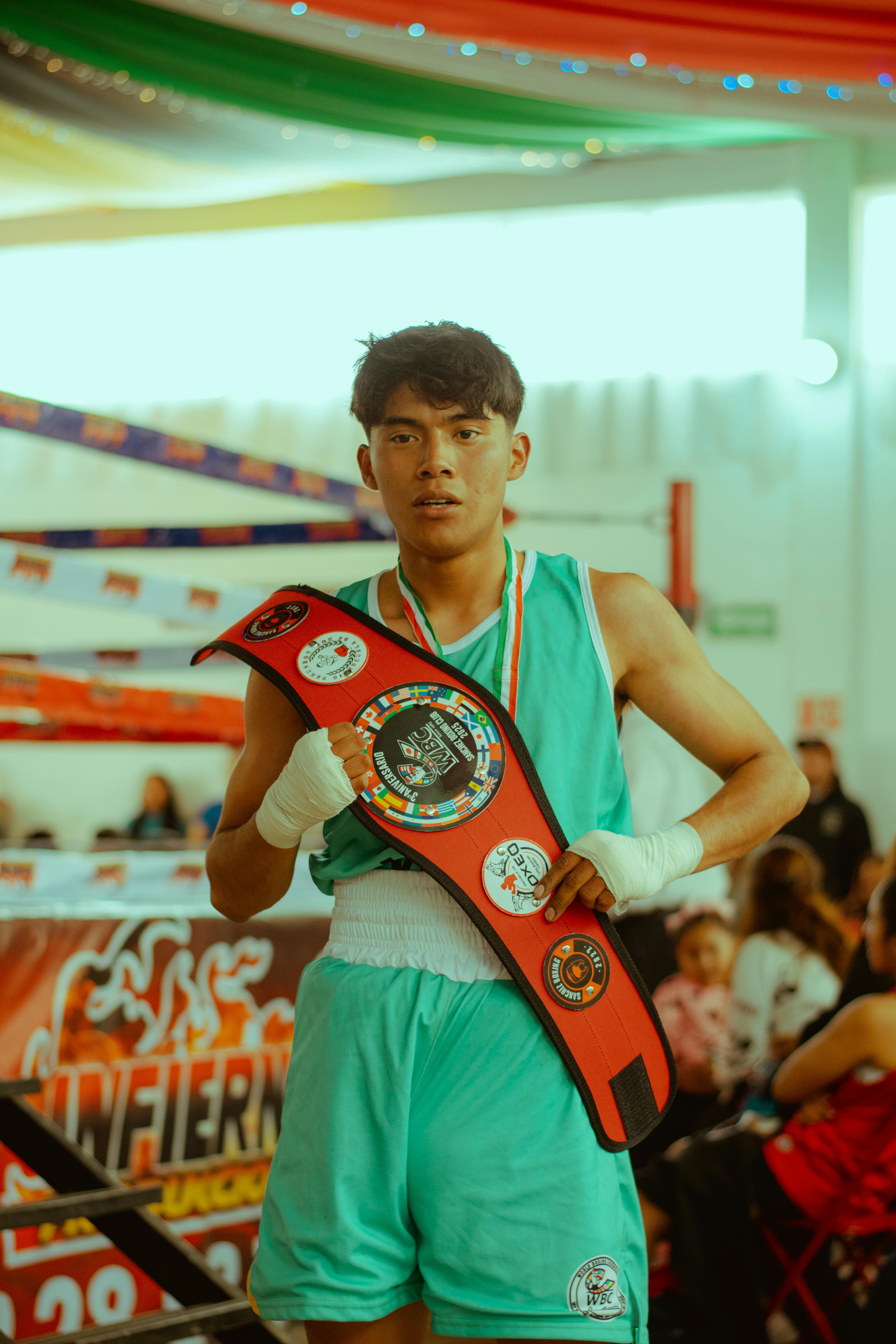 Young Boxer Celebrating Victory Indoors · Free Stock Photo