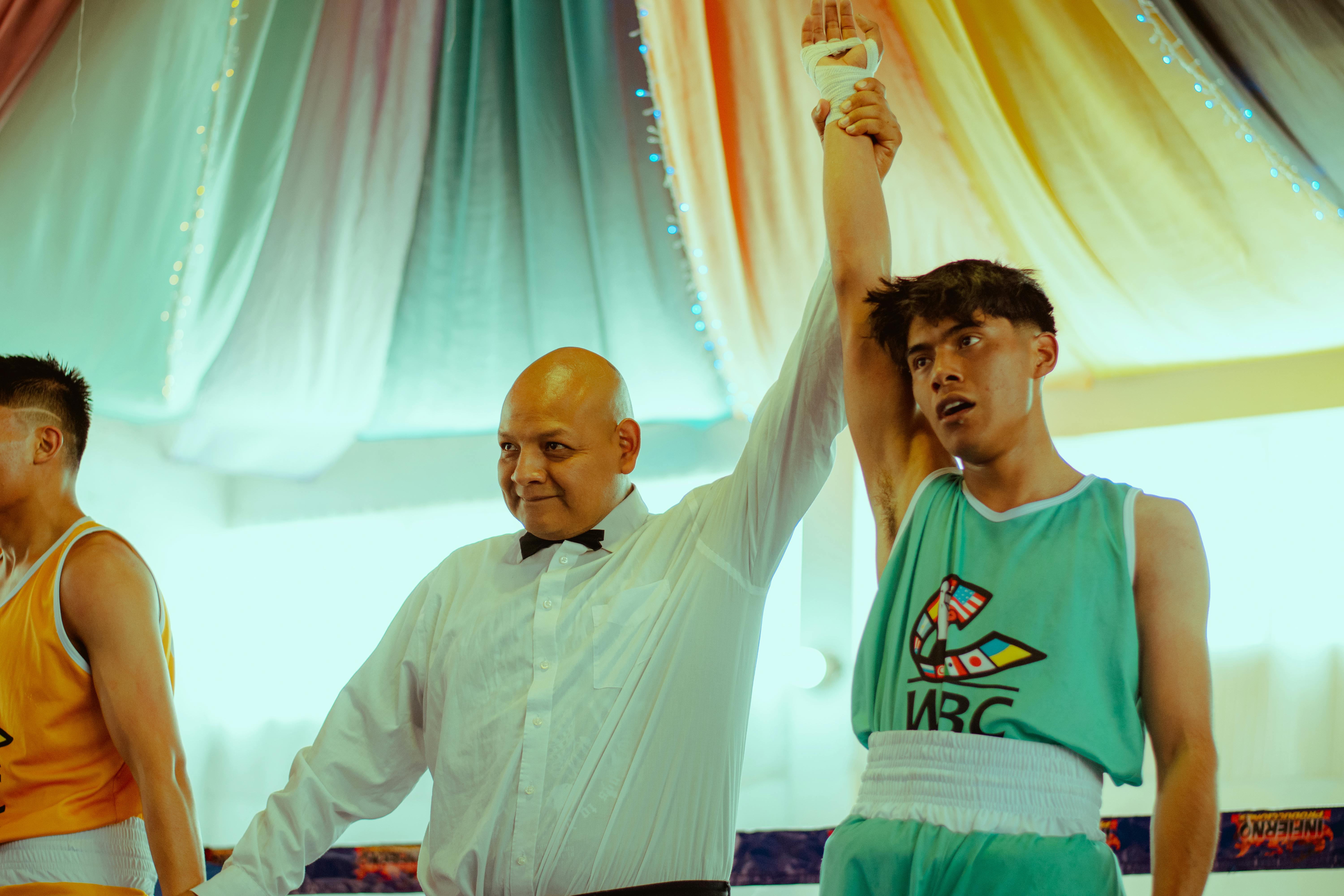 Teen Boxer Victorious in Colorful Indoor Arena · Free Stock Photo