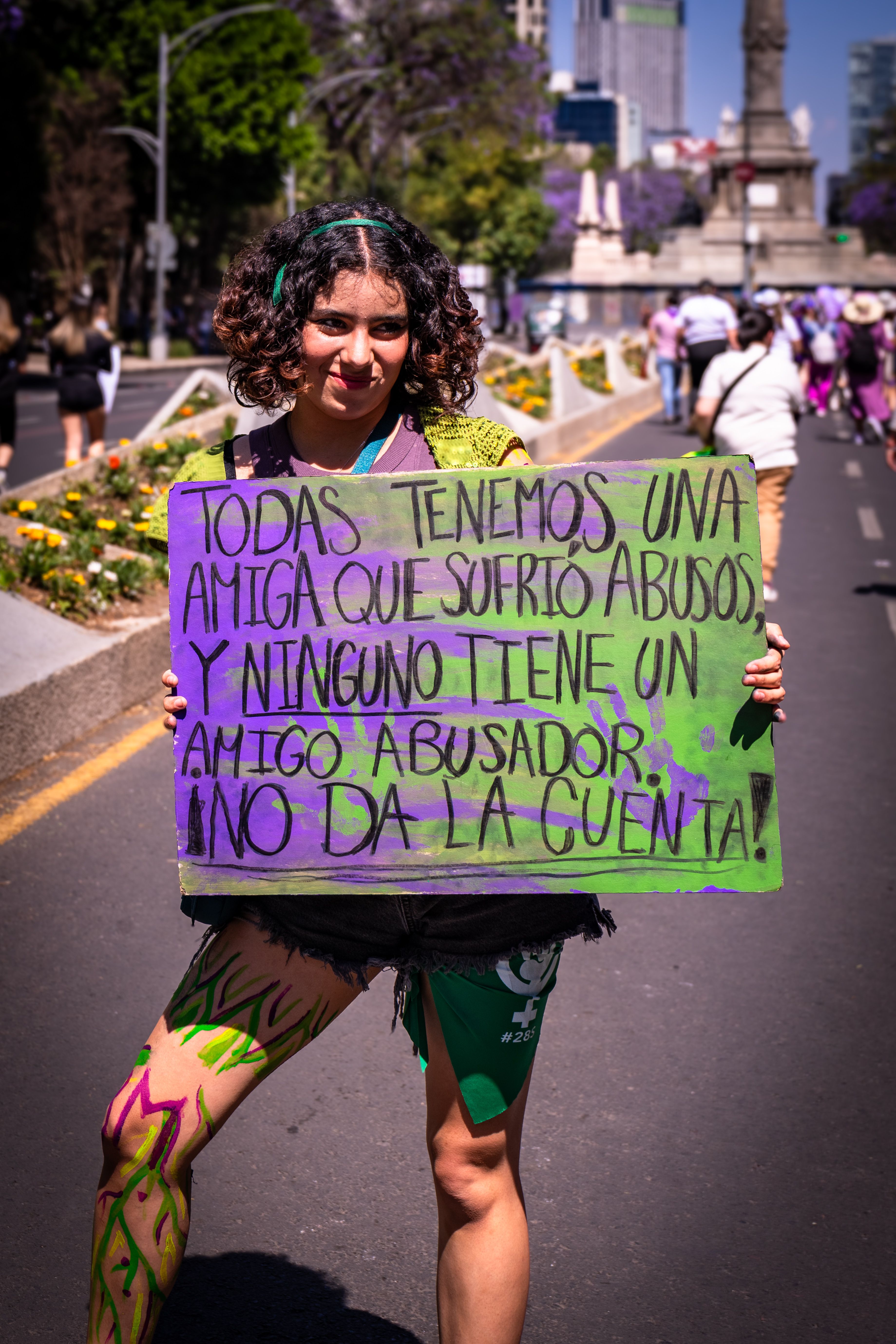 Woman Holding Protest Sign in Urban March · Free Stock Photo