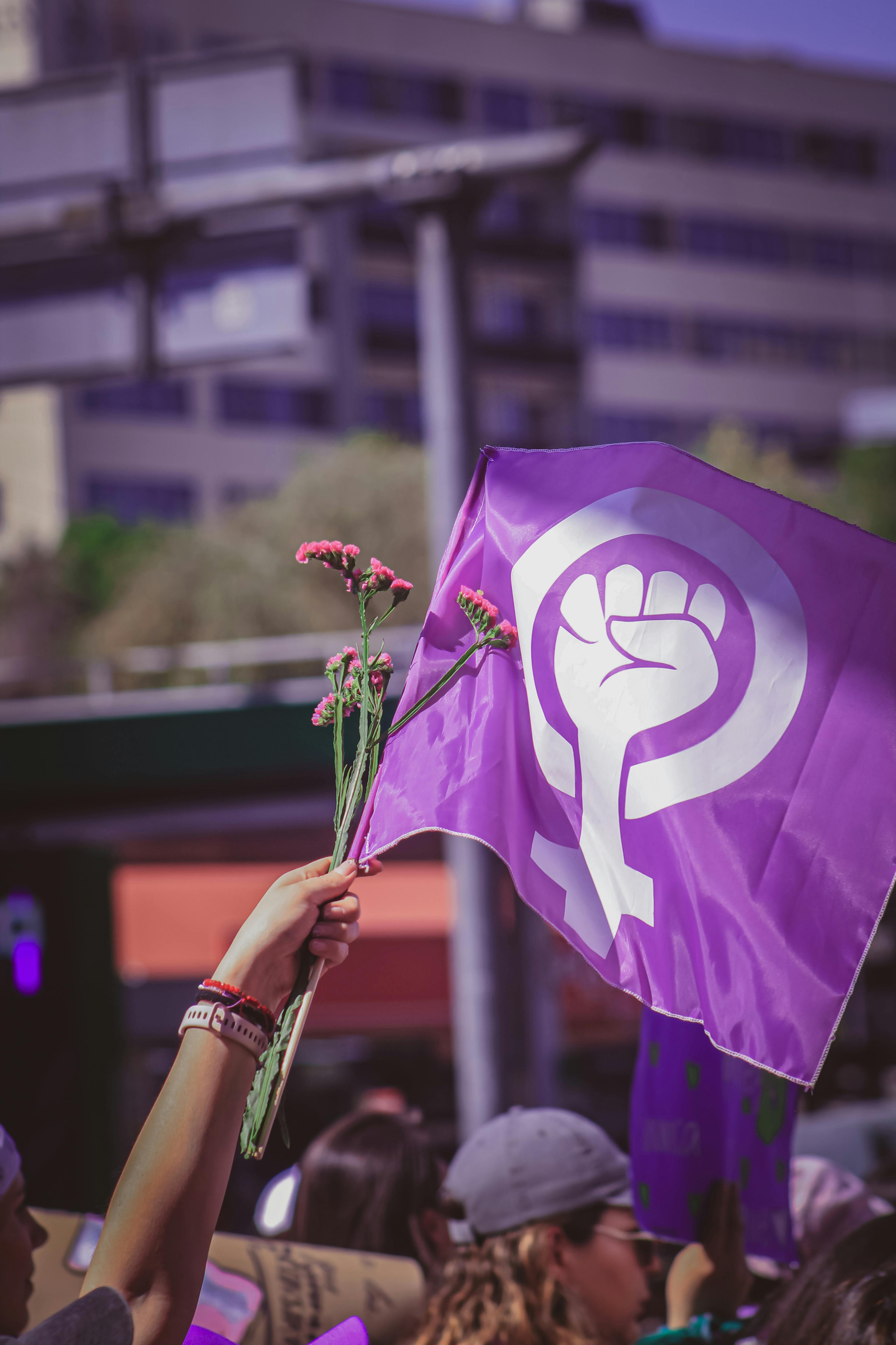 Protest with Feminist Flag and Flowers in Crowd · Free Stock Photo